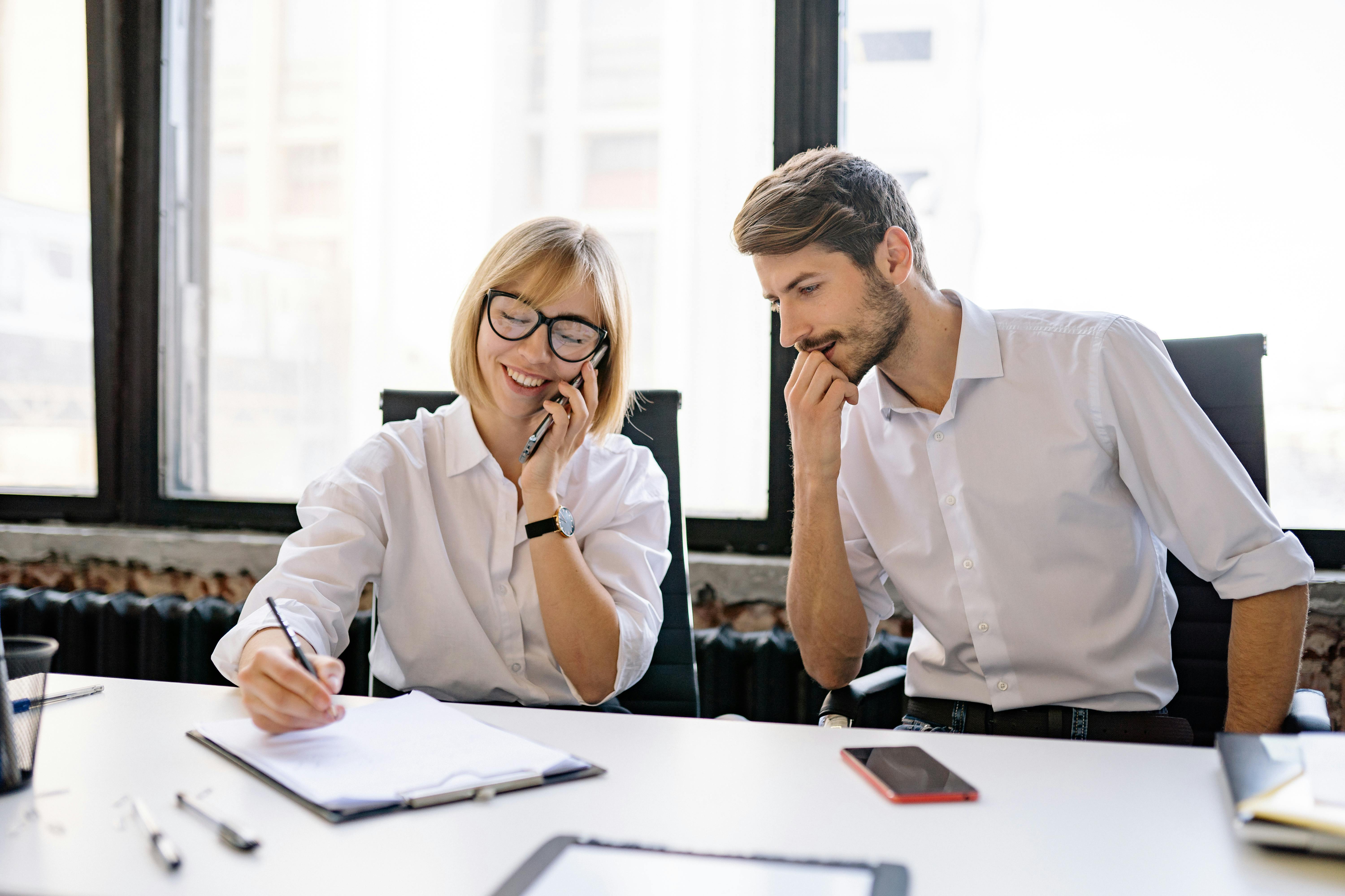 A Group of People at Work Throwing Papers · Free Stock Photo