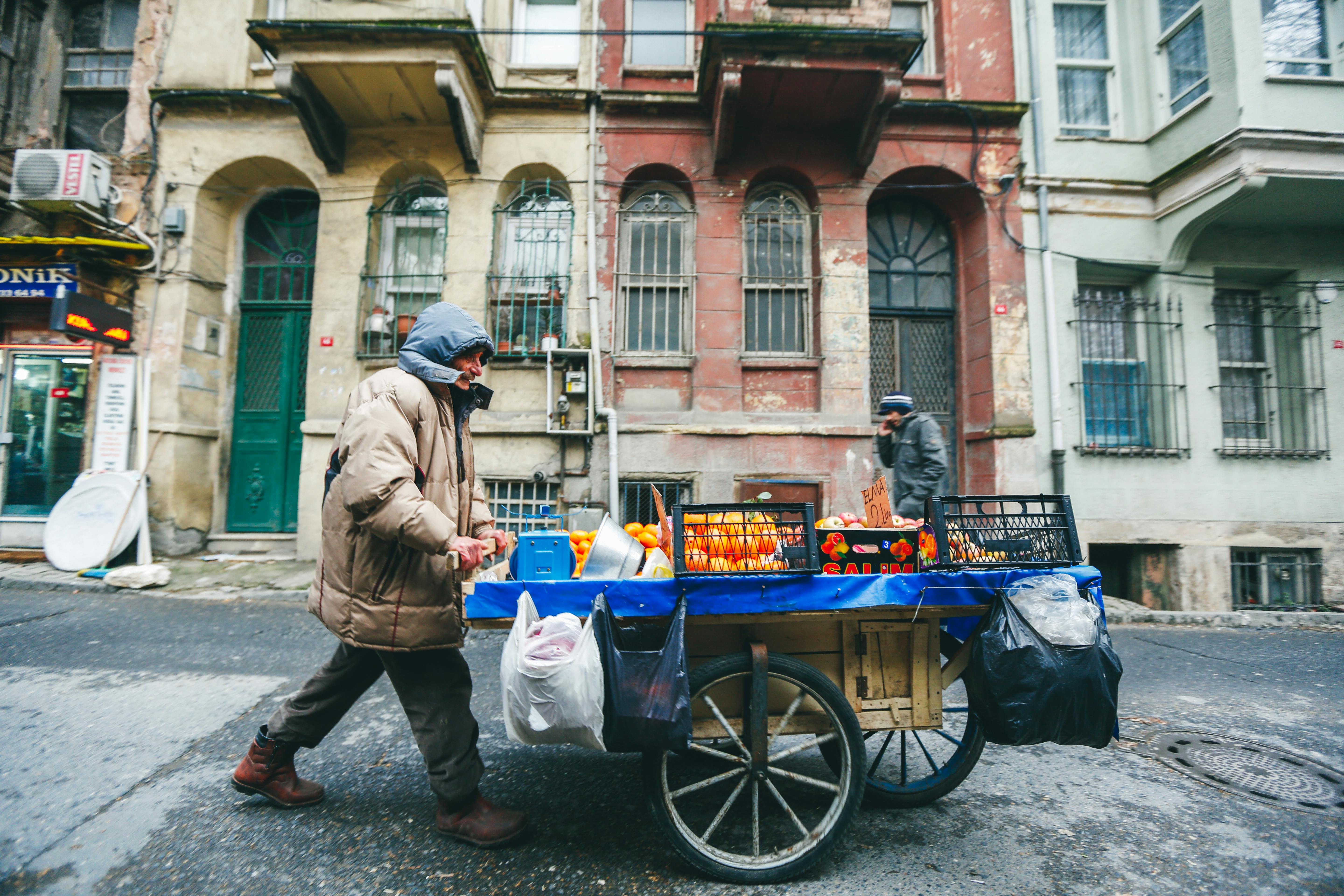 Woman and Man Selling Food on City Street · Free Stock Photo