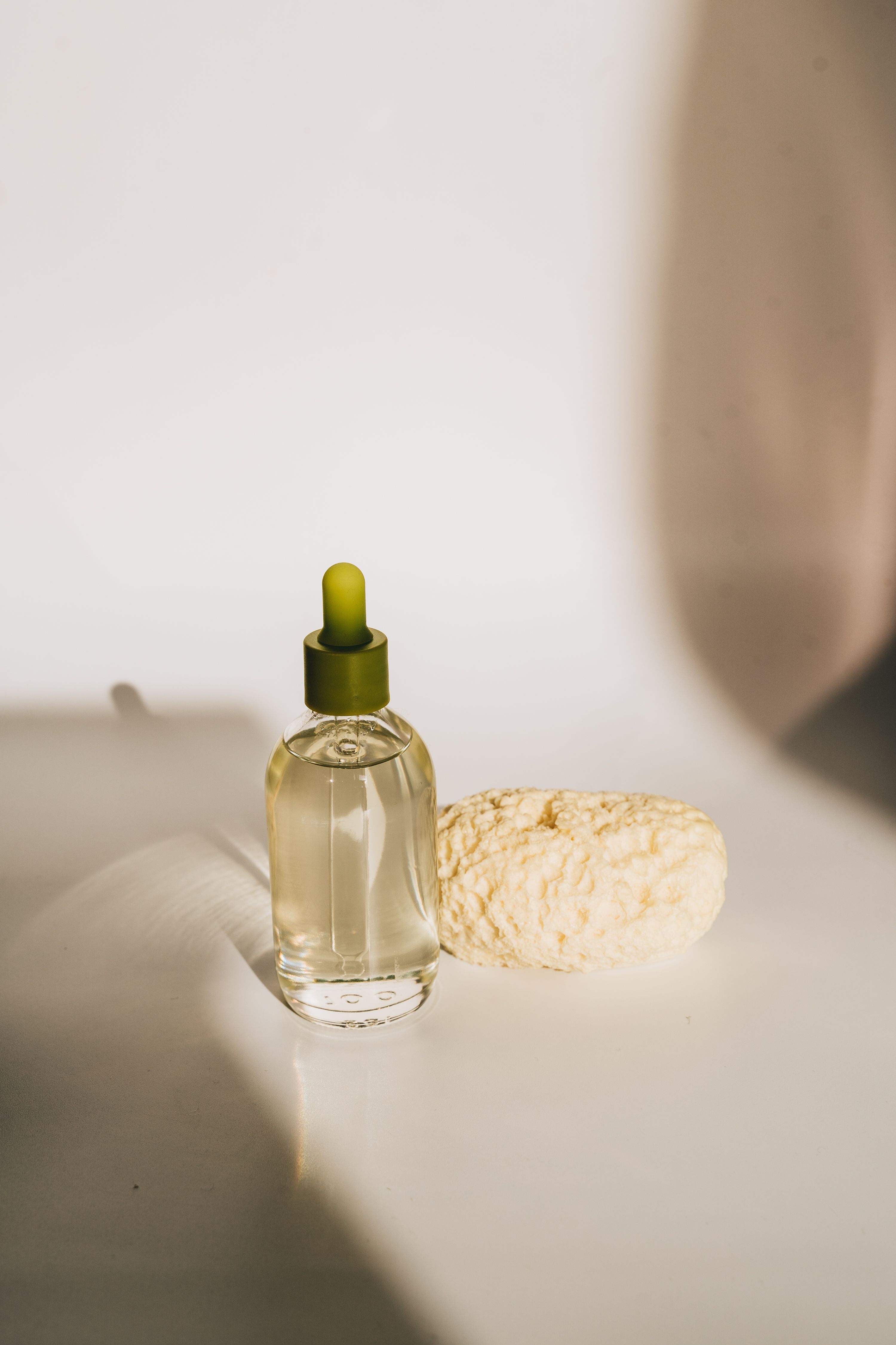 Close Up Shot of Clear Glass Cosmetic Bottle · Free Stock Photo