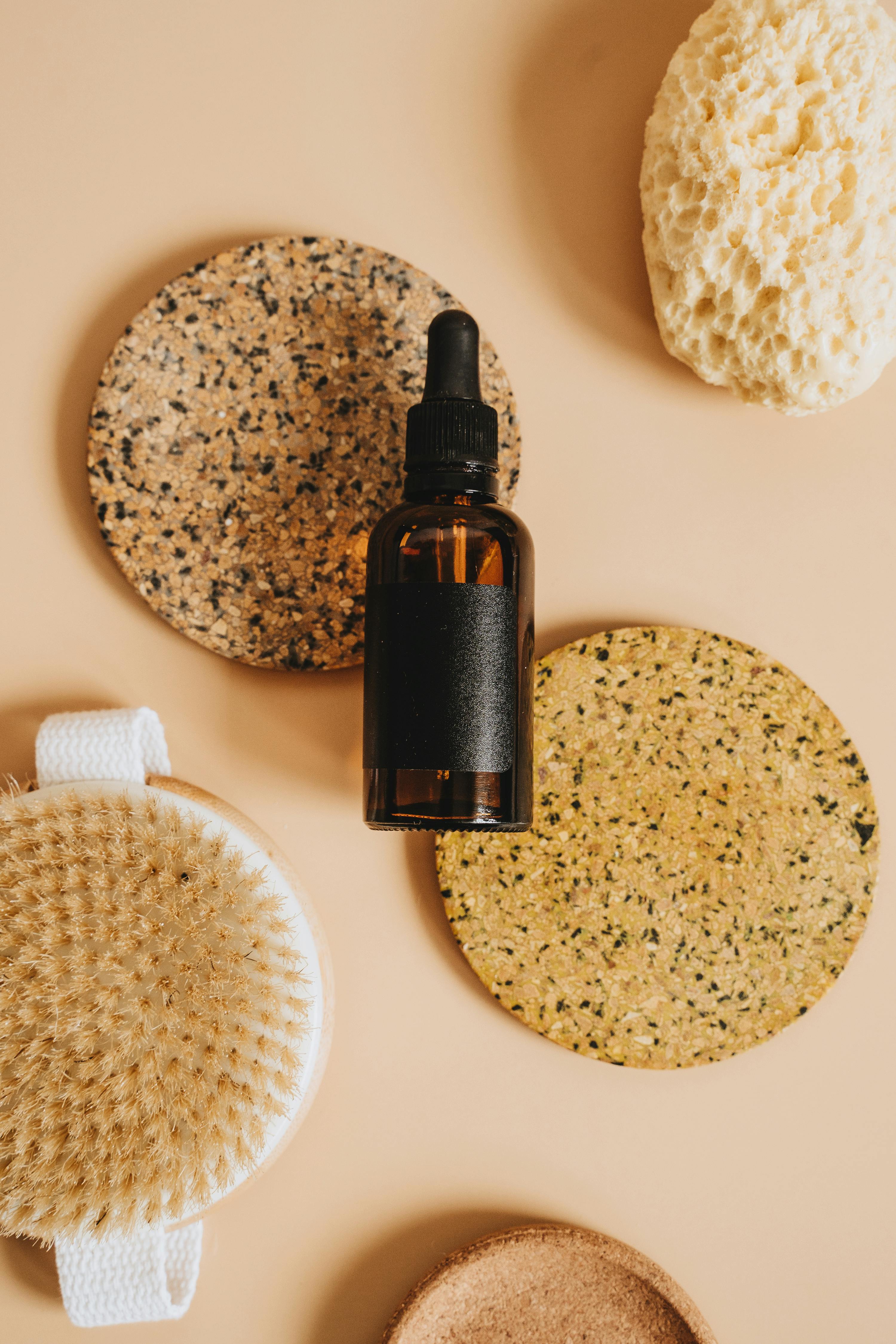 Brown Glass Bottle Pump on a Cork Coaster · Free Stock Photo