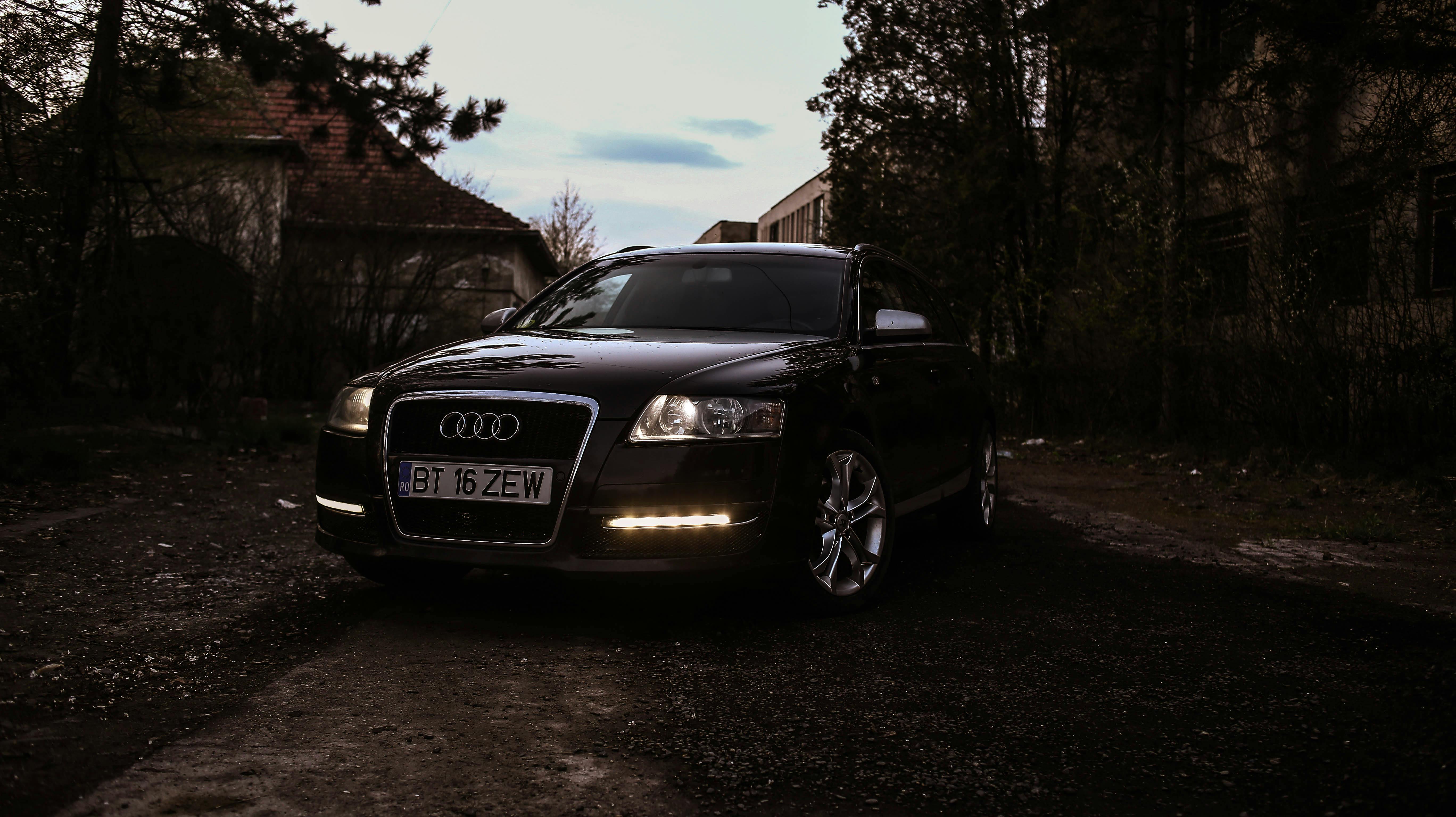 A Black Car on a Dirt Driveway · Free Stock Photo