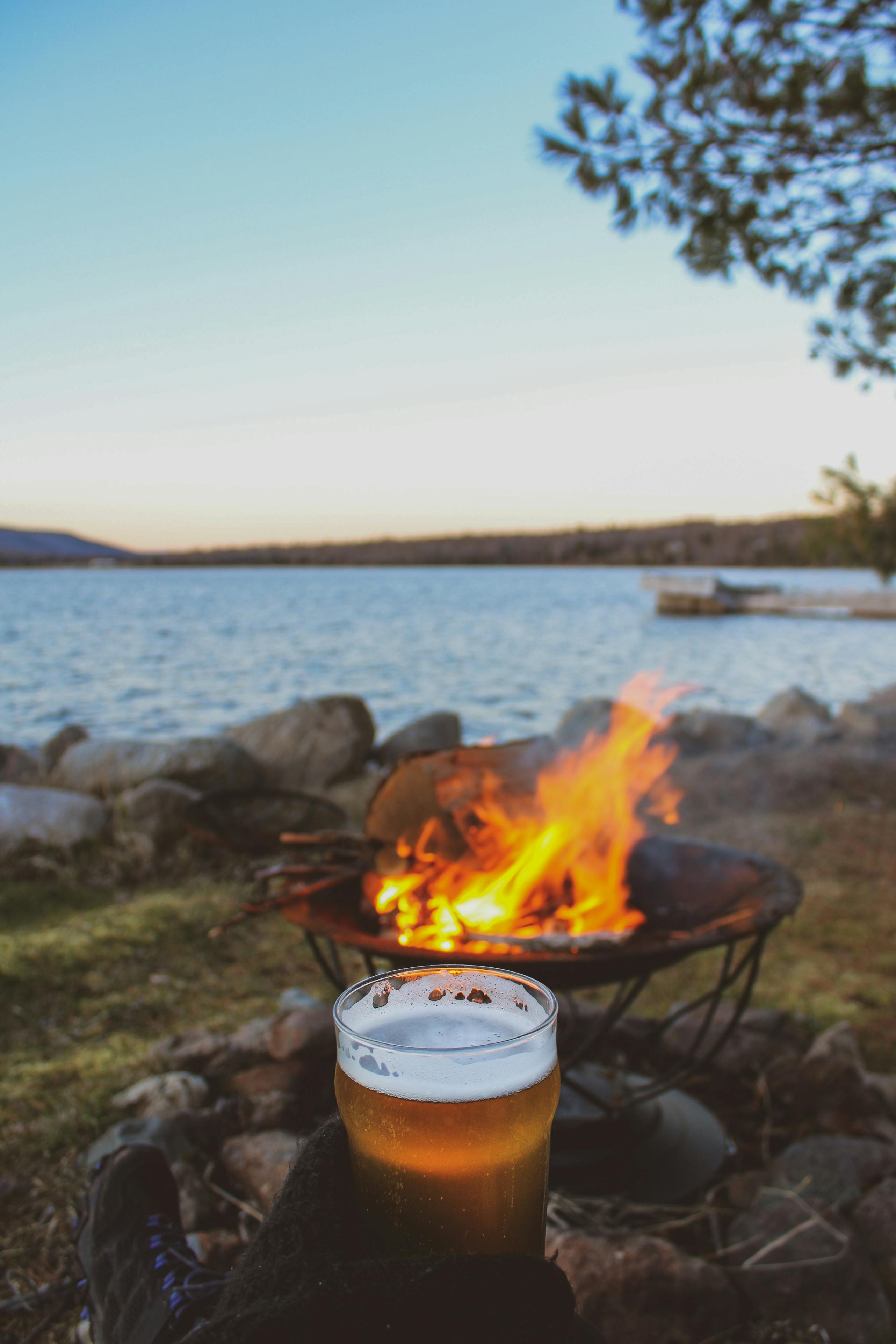 A Point of View of a Person Having a Beer in Front of a Campfire · Free ...