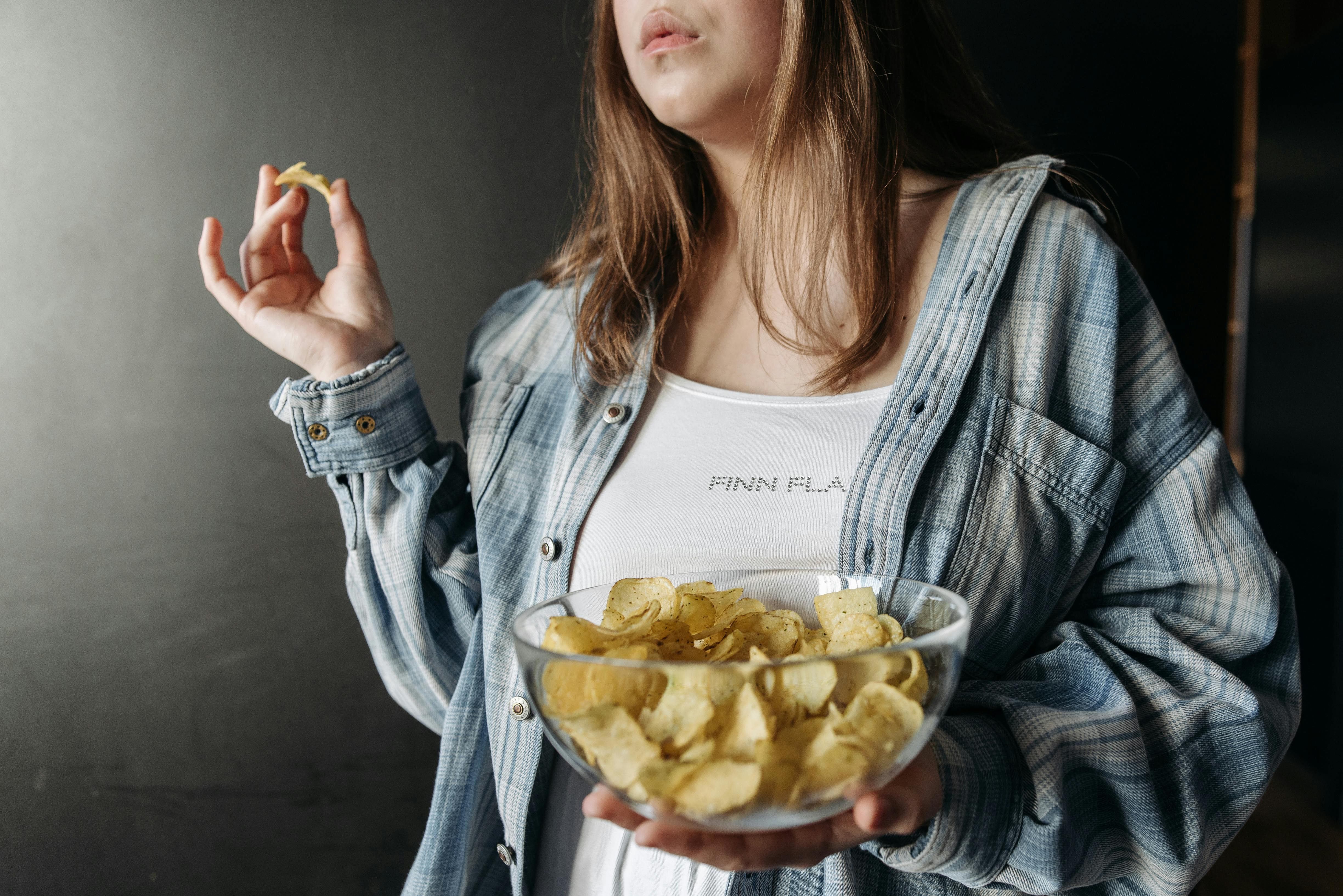 A Person Carrying a Bowl of Potato Chips · Free Stock Photo