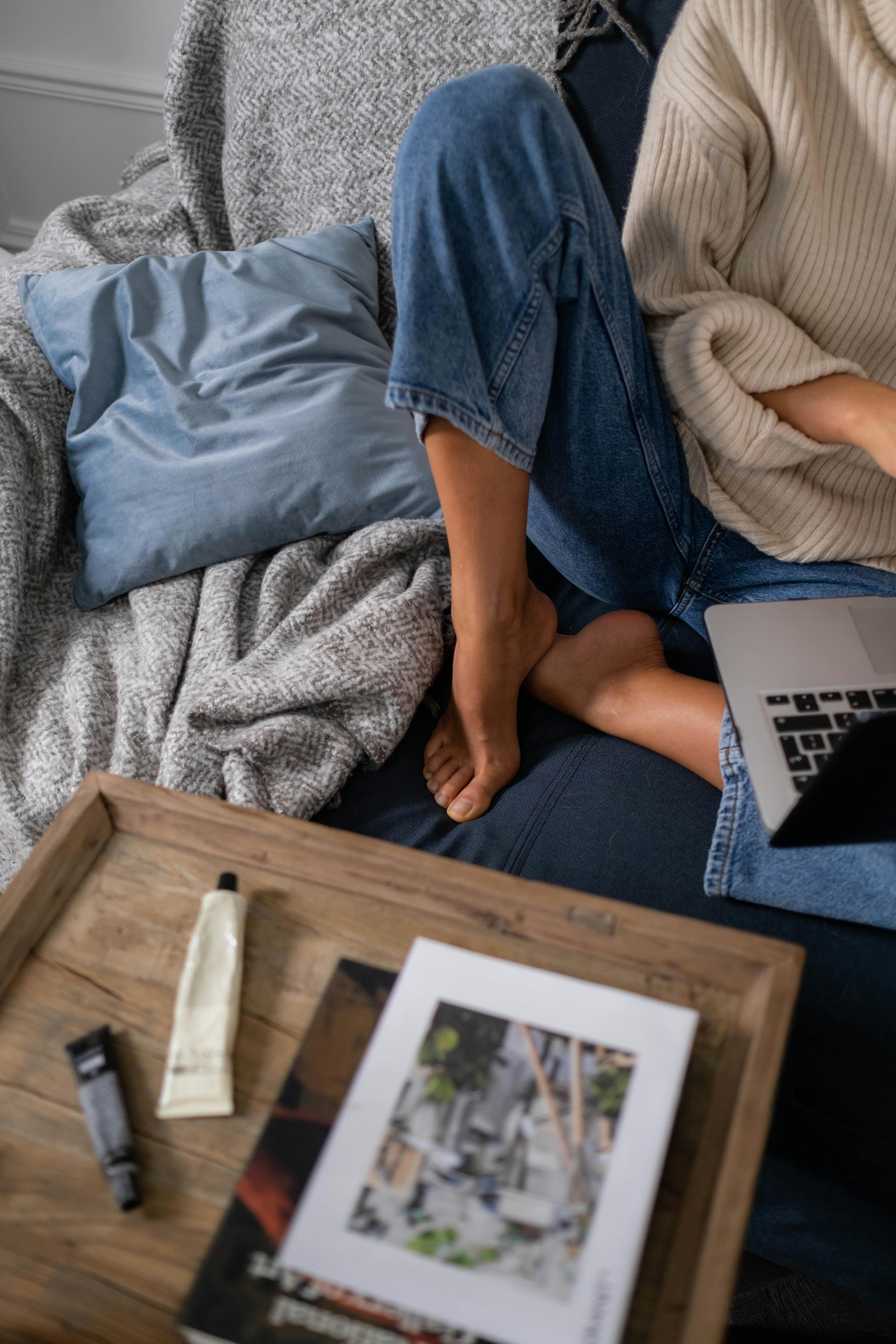 Person in Denim Pants Sitting On The Couch · Free Stock Photo