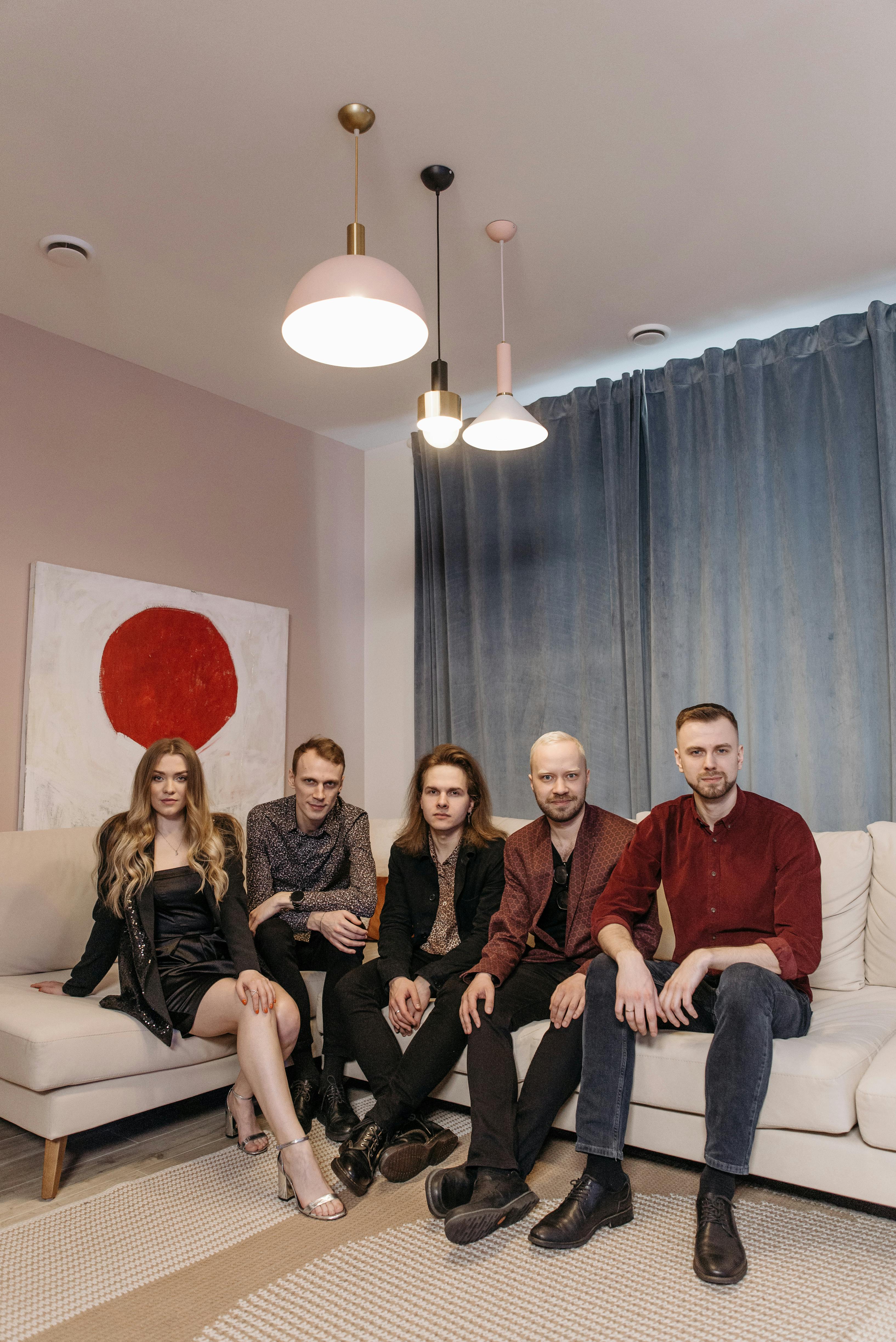 Group of People Sitting on White Couch · Free Stock Photo