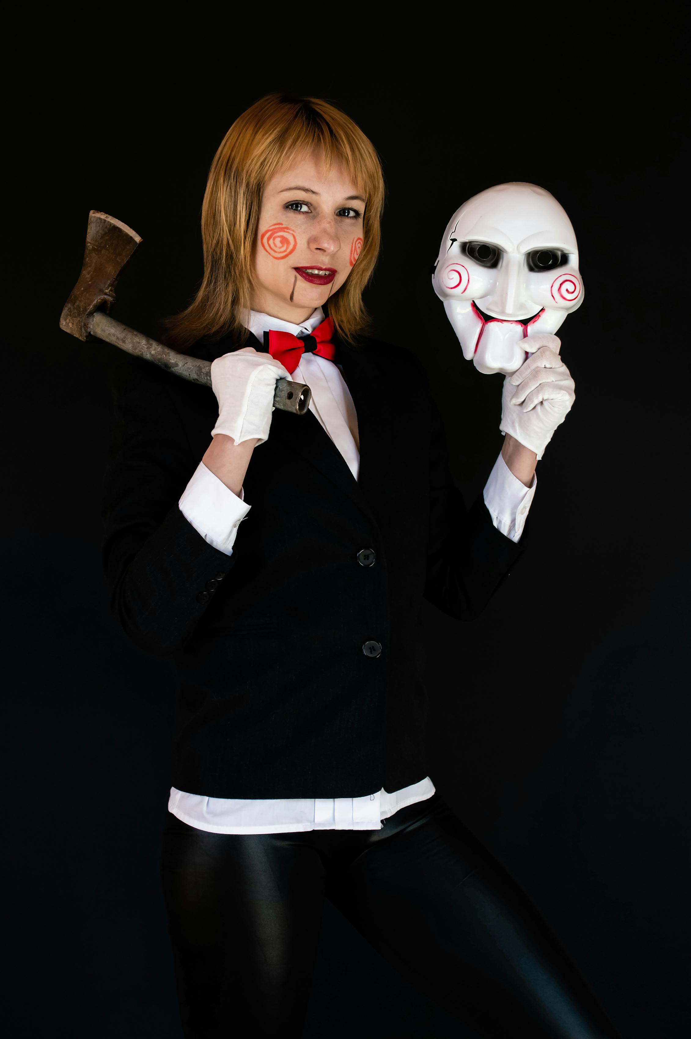 Woman in Face Paint Crouching in Forest Holding on to a Tree Branch ...