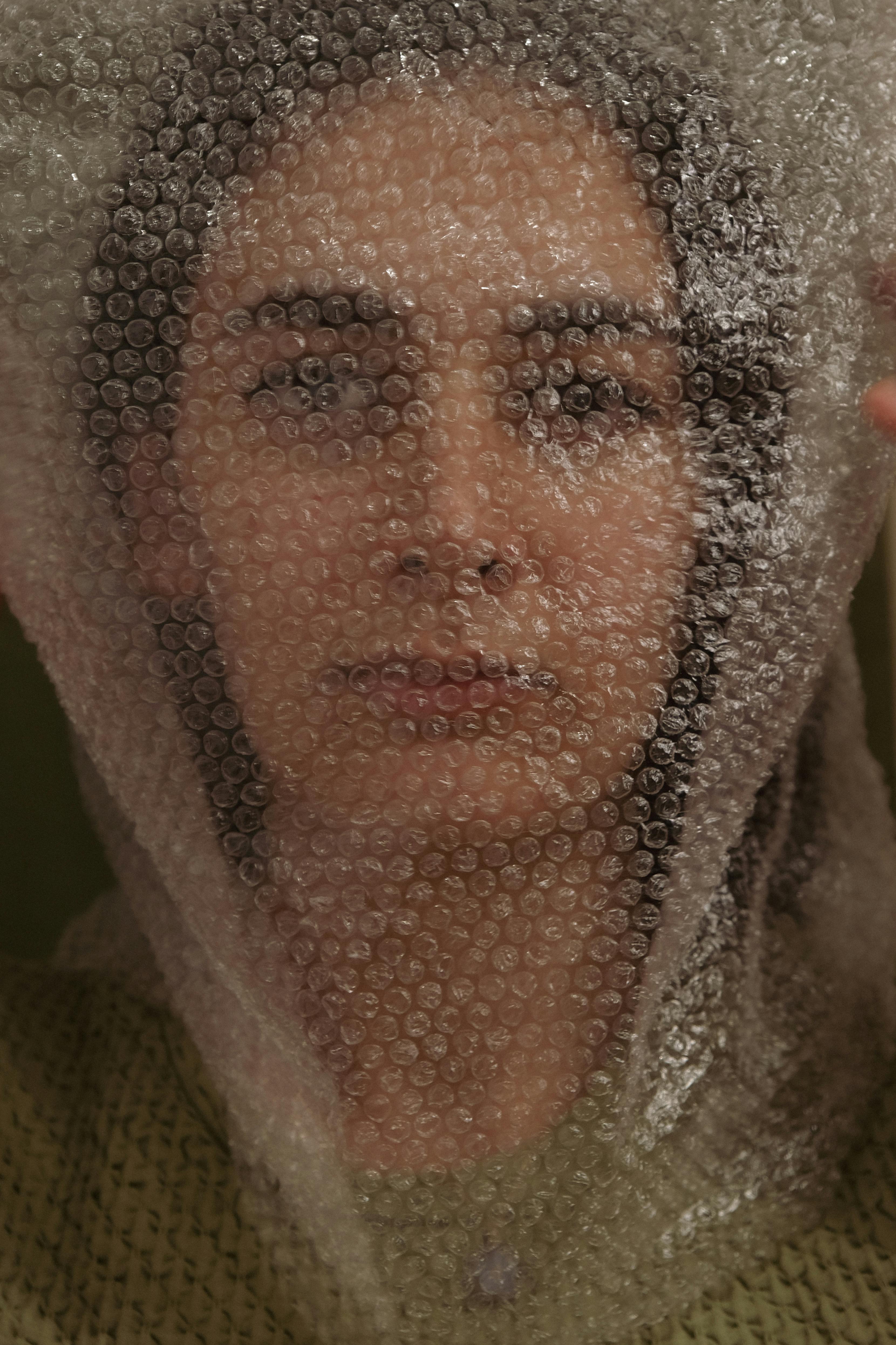 A Woman Holding a Bubble Wrap · Free Stock Photo