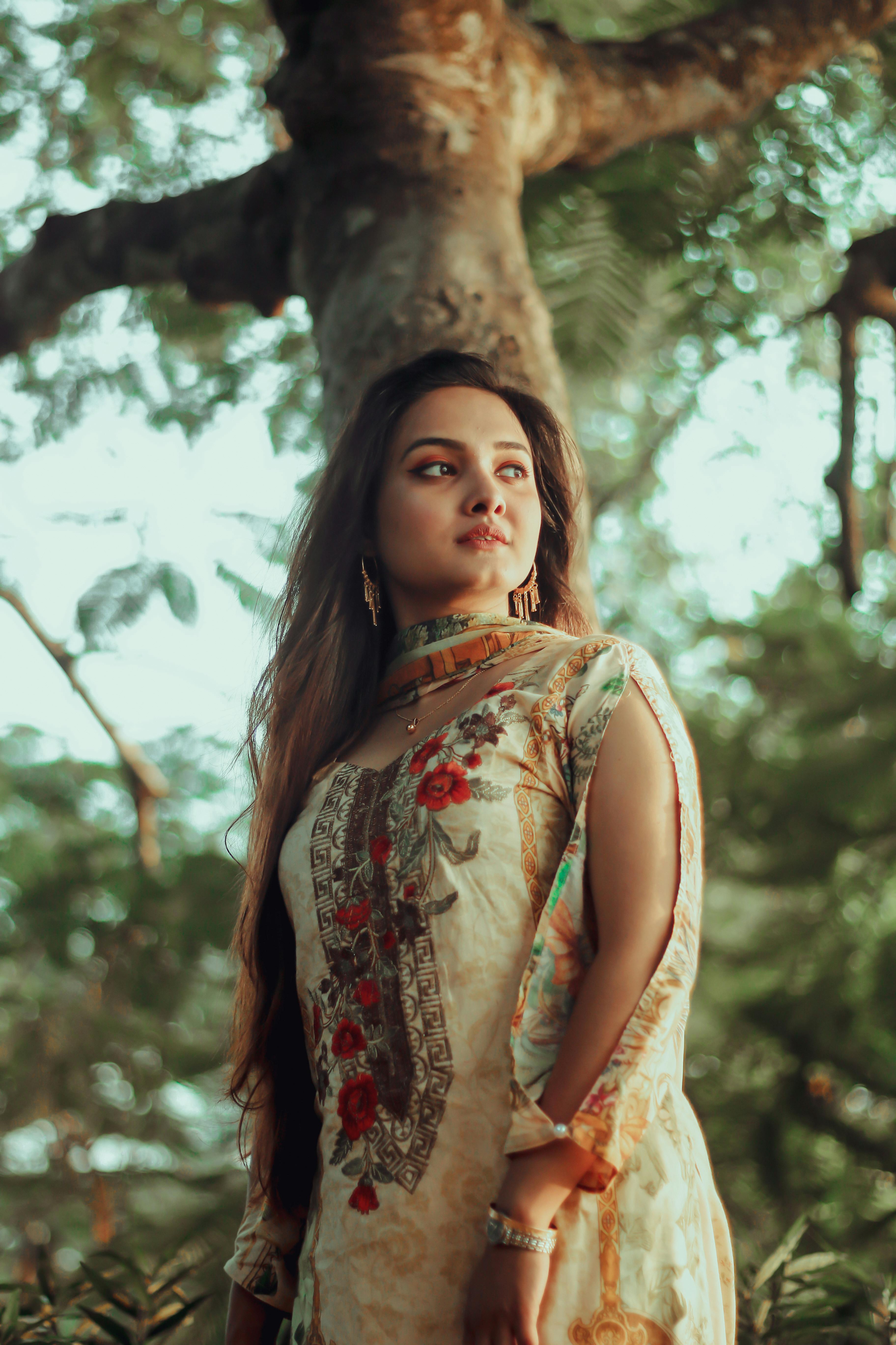 Woman Standing Beside a Tree · Free Stock Photo