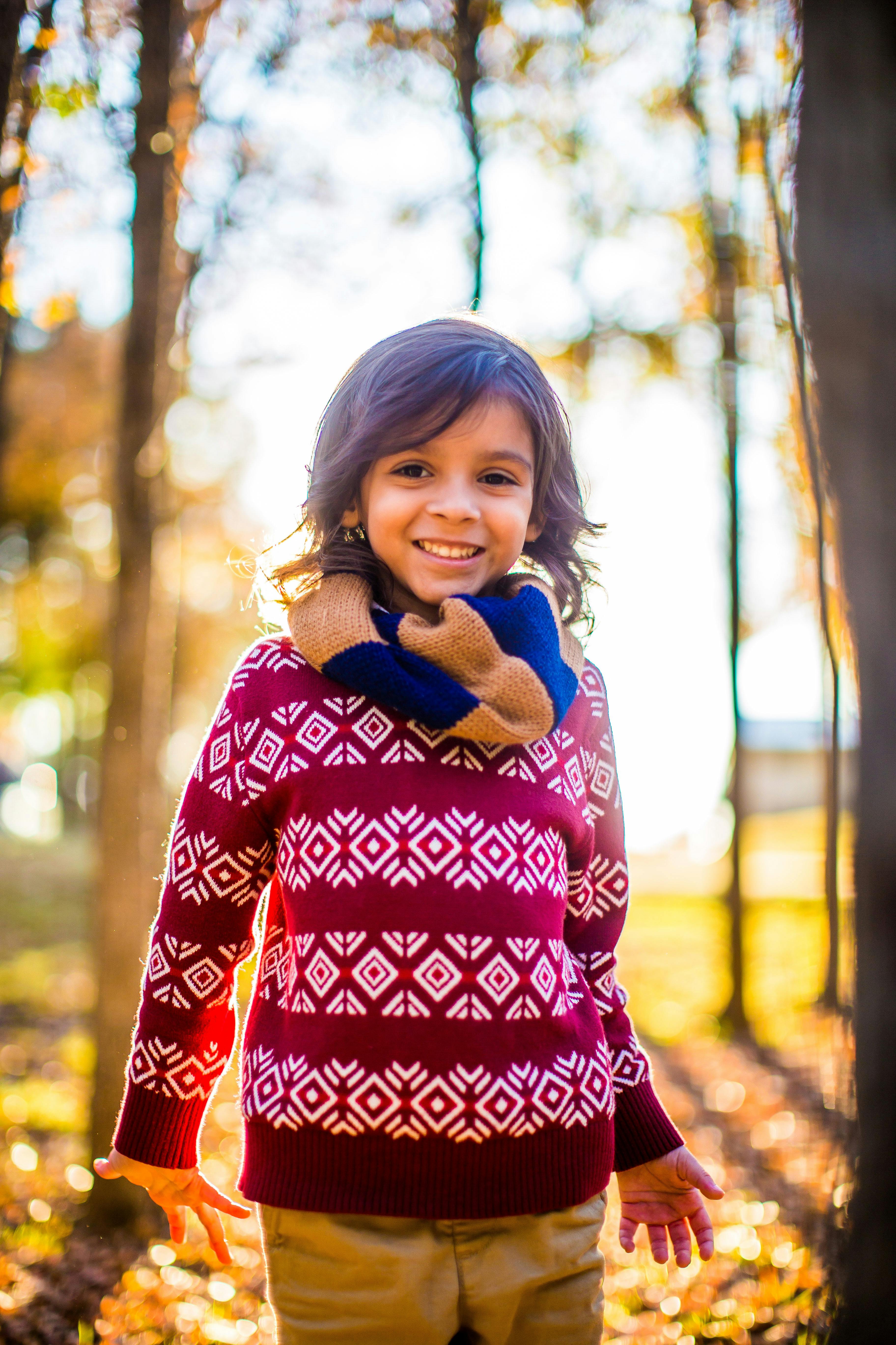 Happy little child smiling while peeking from tent · Free Stock Photo
