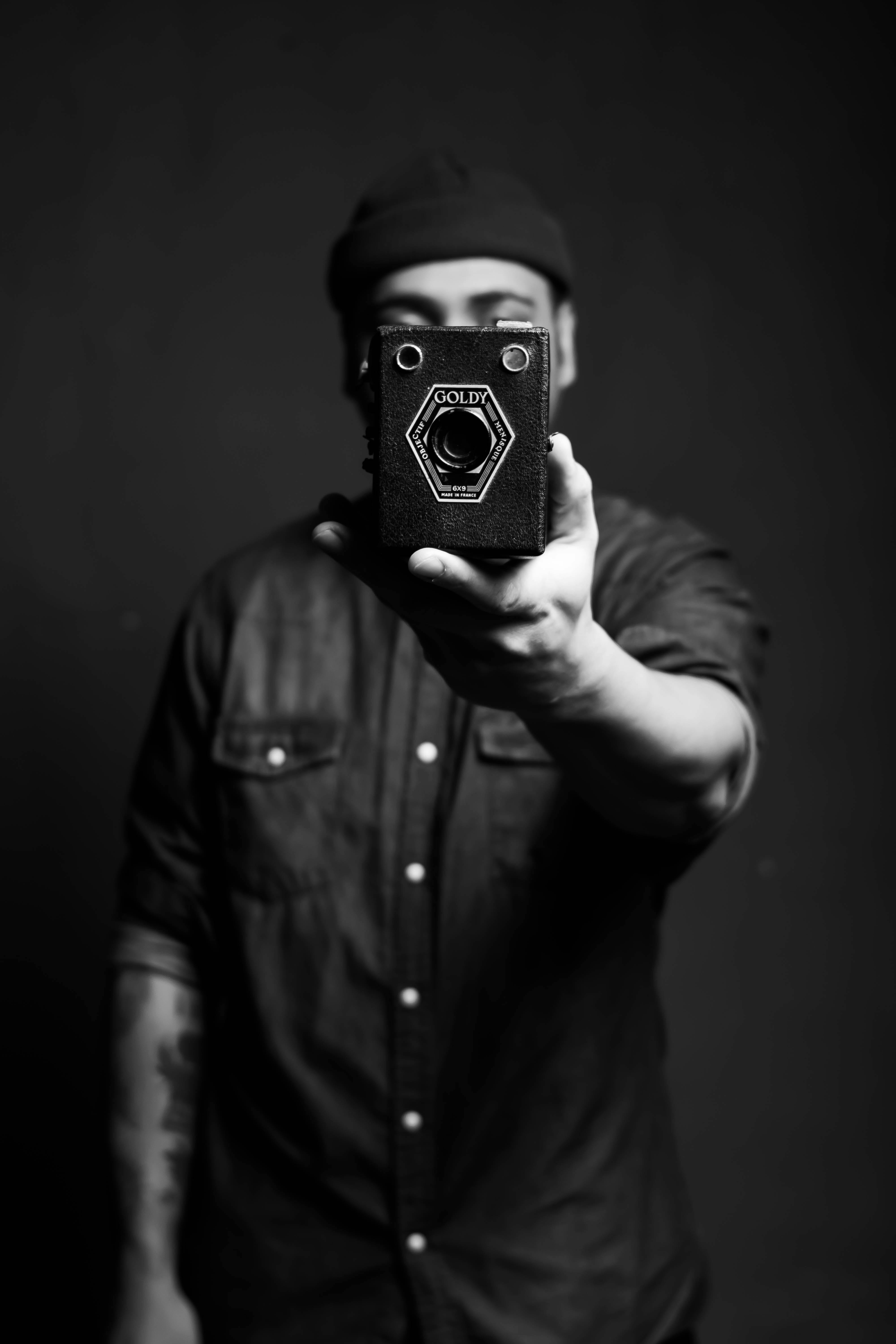 Gray Scale Photo of Man Holding Analog Camera · Free Stock Photo