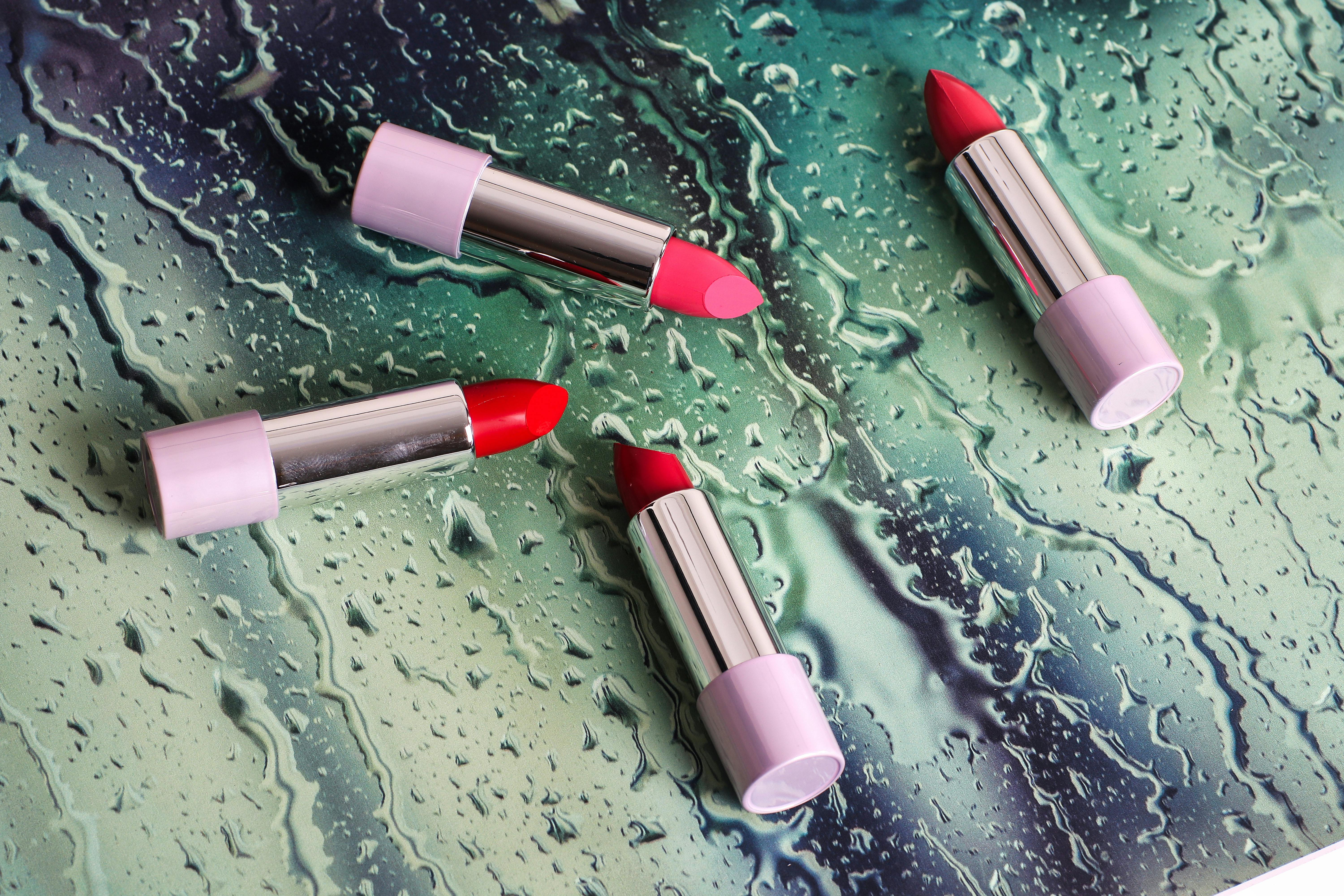 A Close-Up Shot of Lipsticks on a Wet Surface · Free Stock Photo