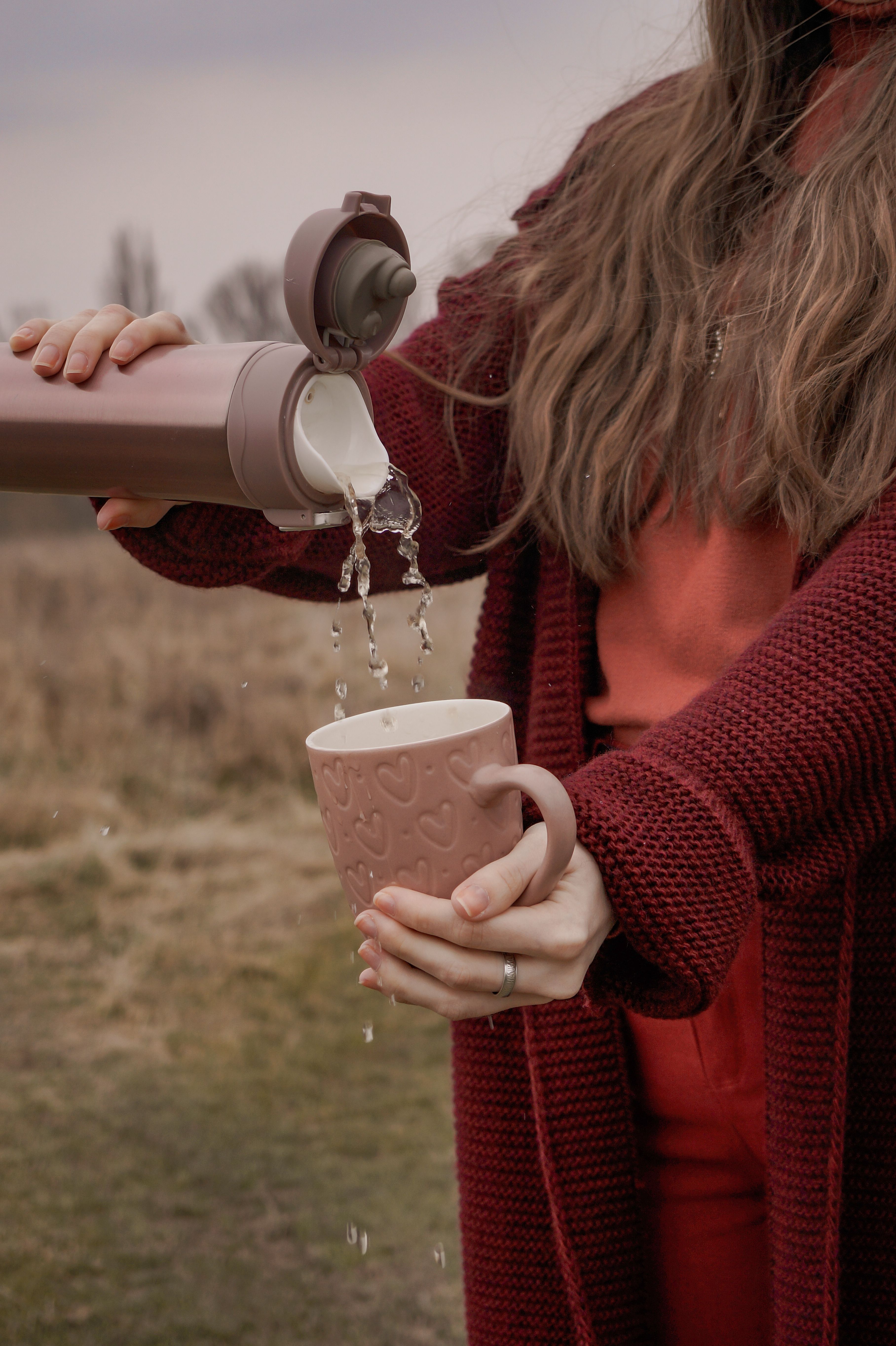 Woman Pouring Water on Pink Ceramic Mug · Free Stock Photo