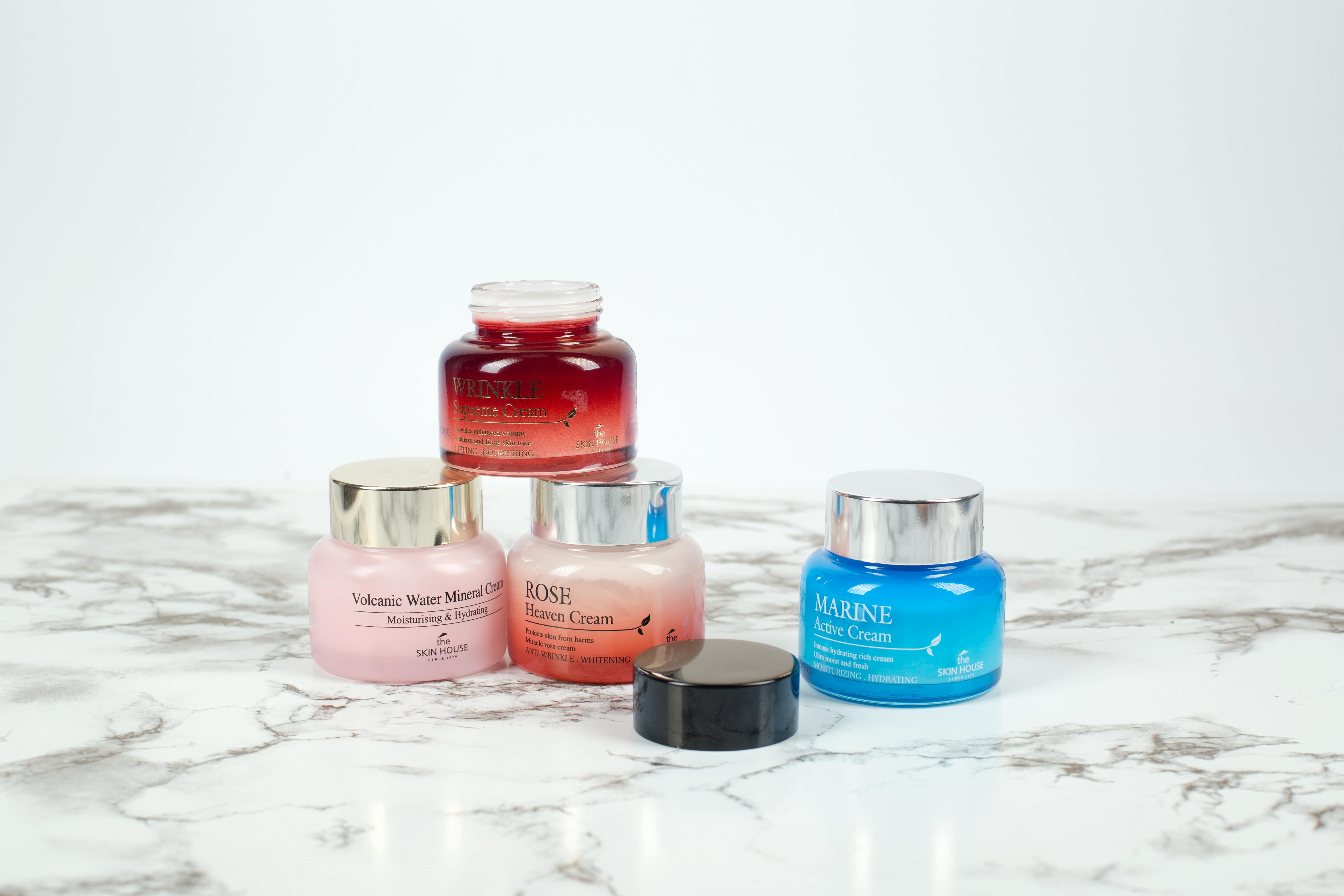 Different Types of Facial Cream on a White Surface · Free Stock Photo