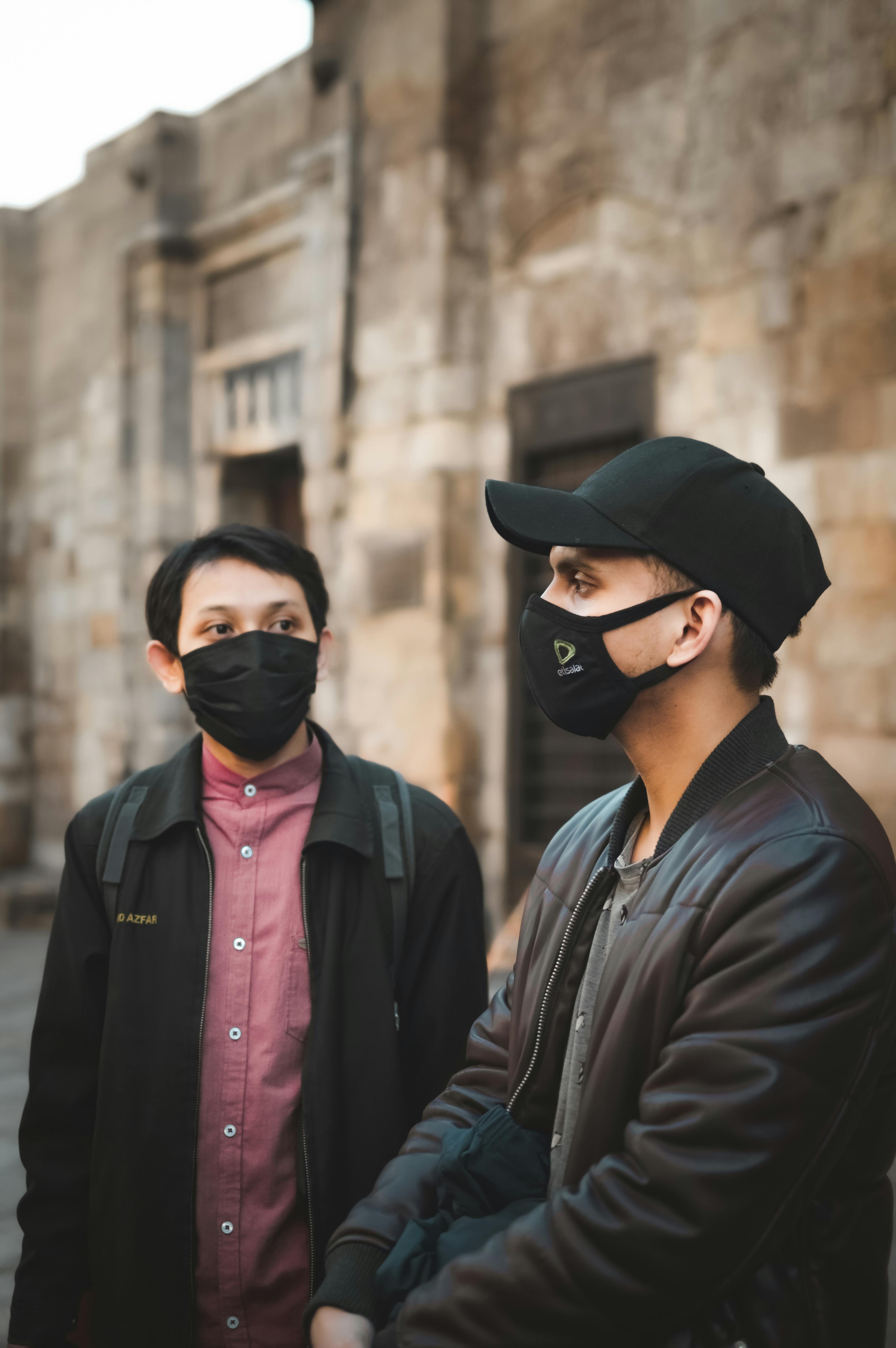 Two Men Wearing Face Masks While Having a Conversation · Free Stock Photo