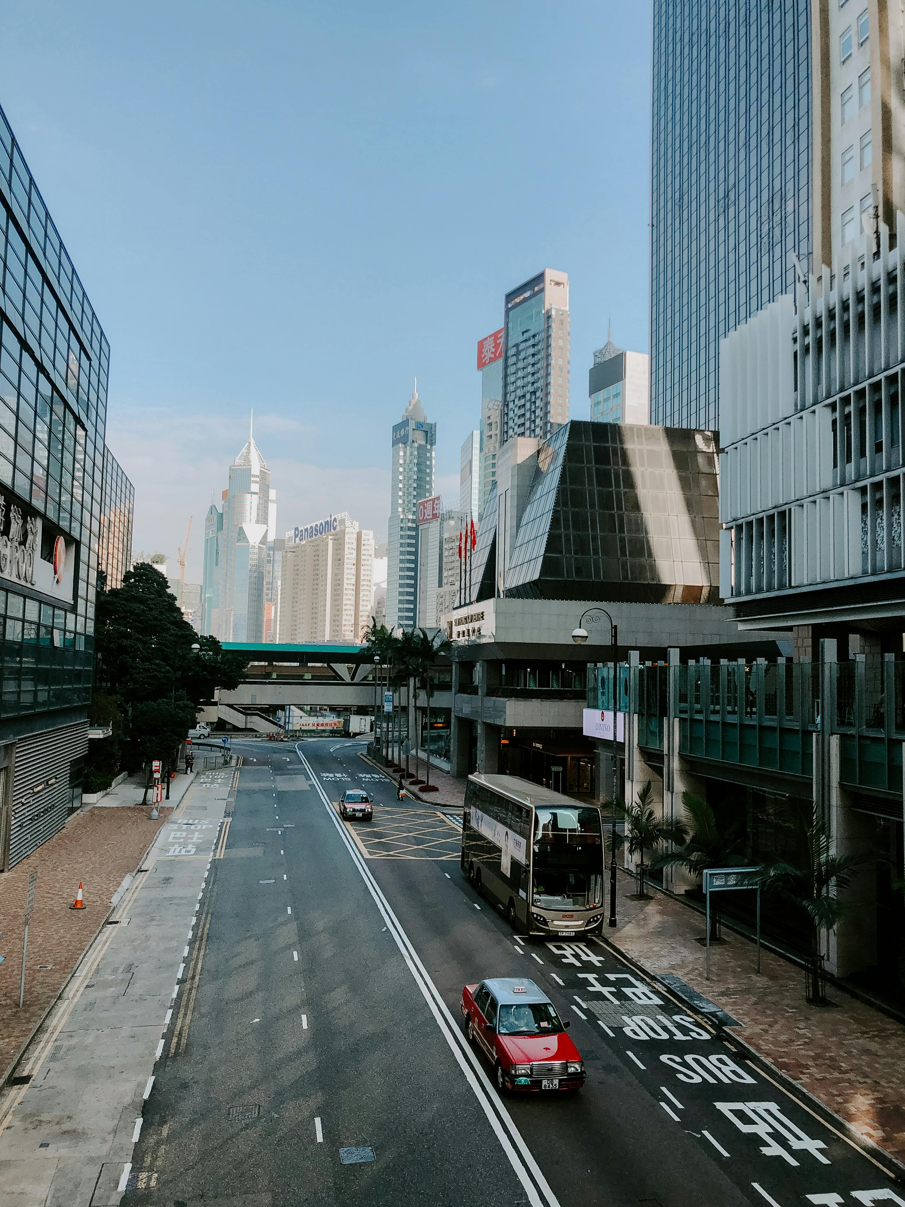 Road between modern multistory buildings · Free Stock Photo