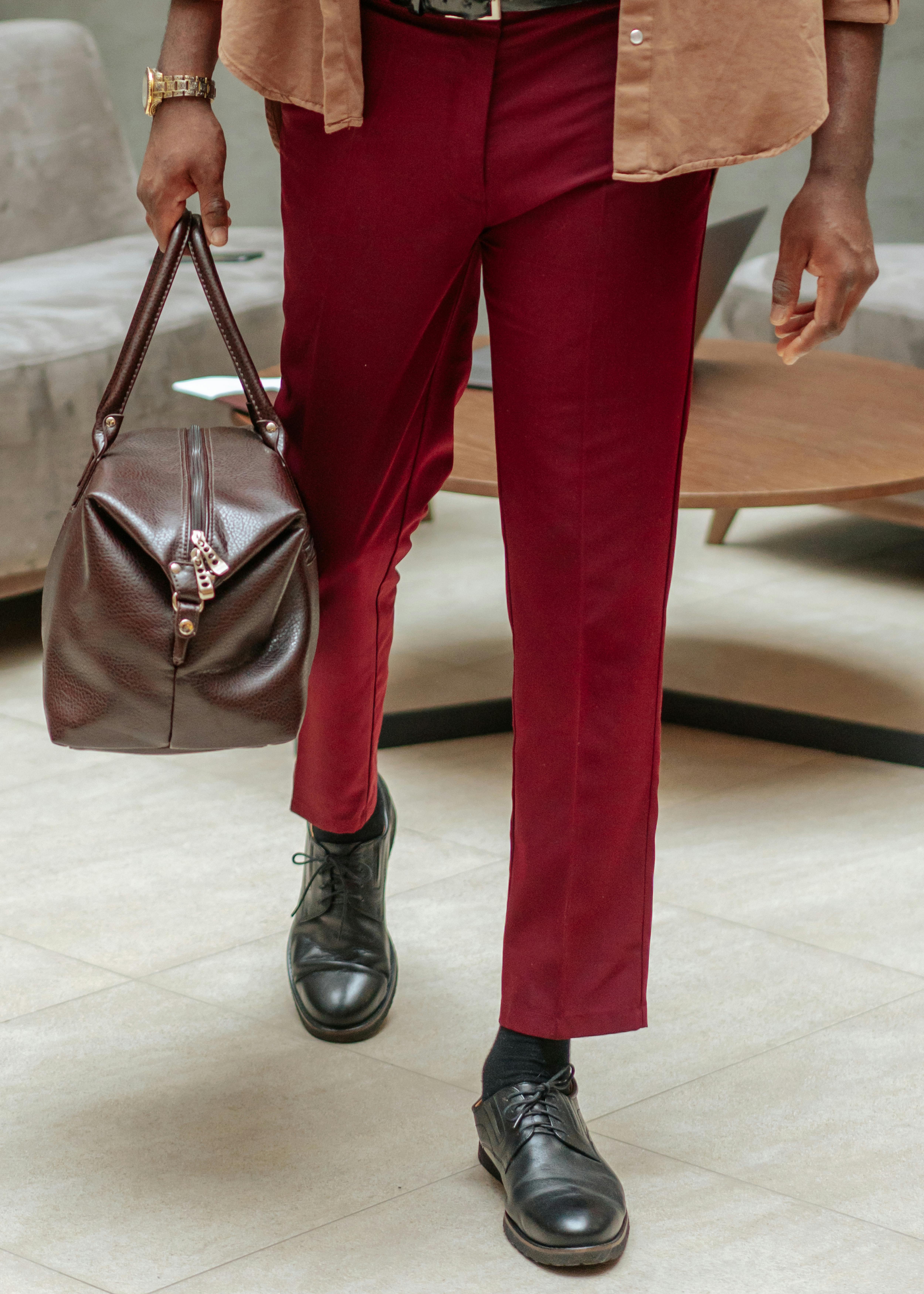 Person Wearing Red Pants Holding a Bag · Free Stock Photo