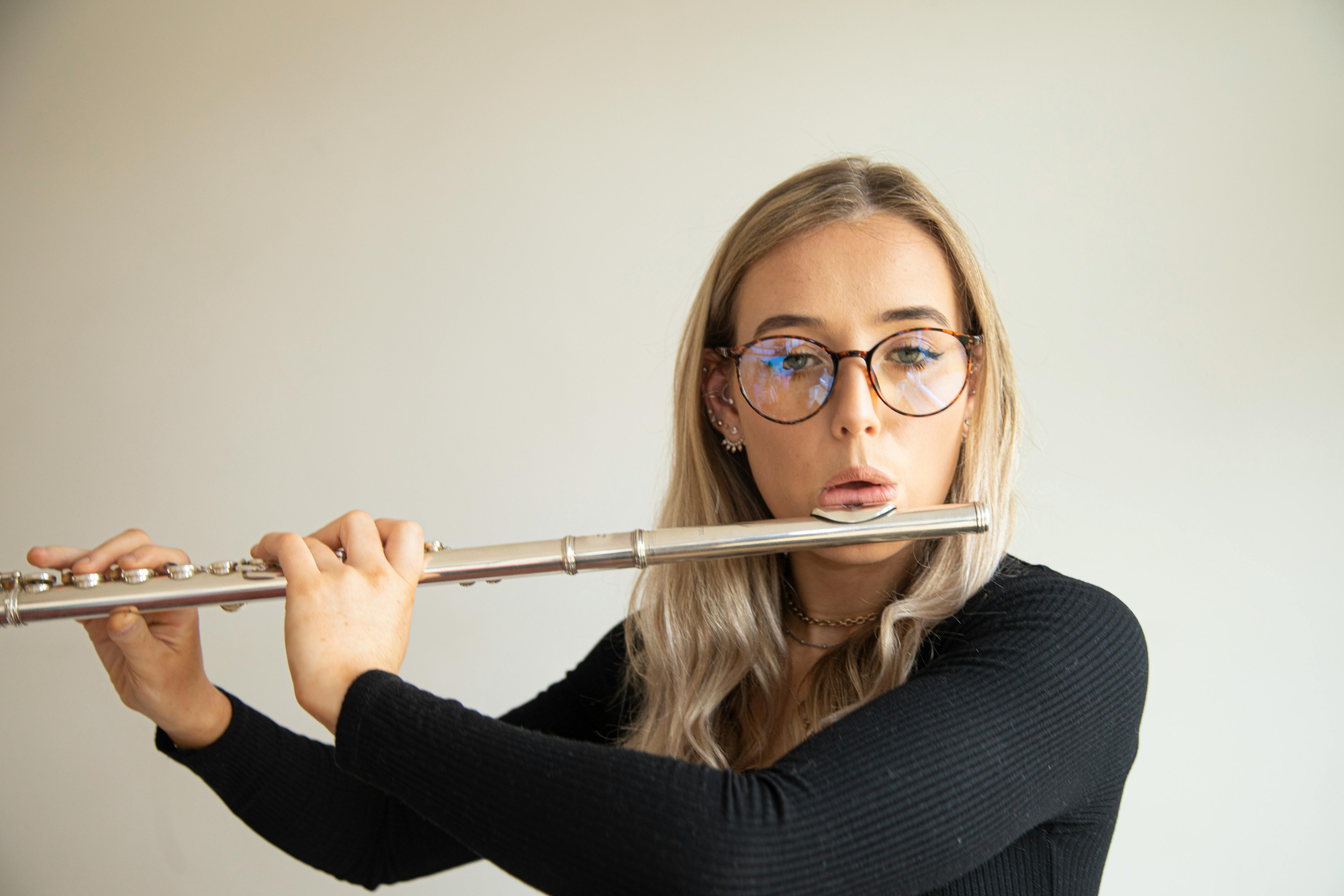 A Man Playing the Flute for a Woman in a Garden · Free Stock Photo