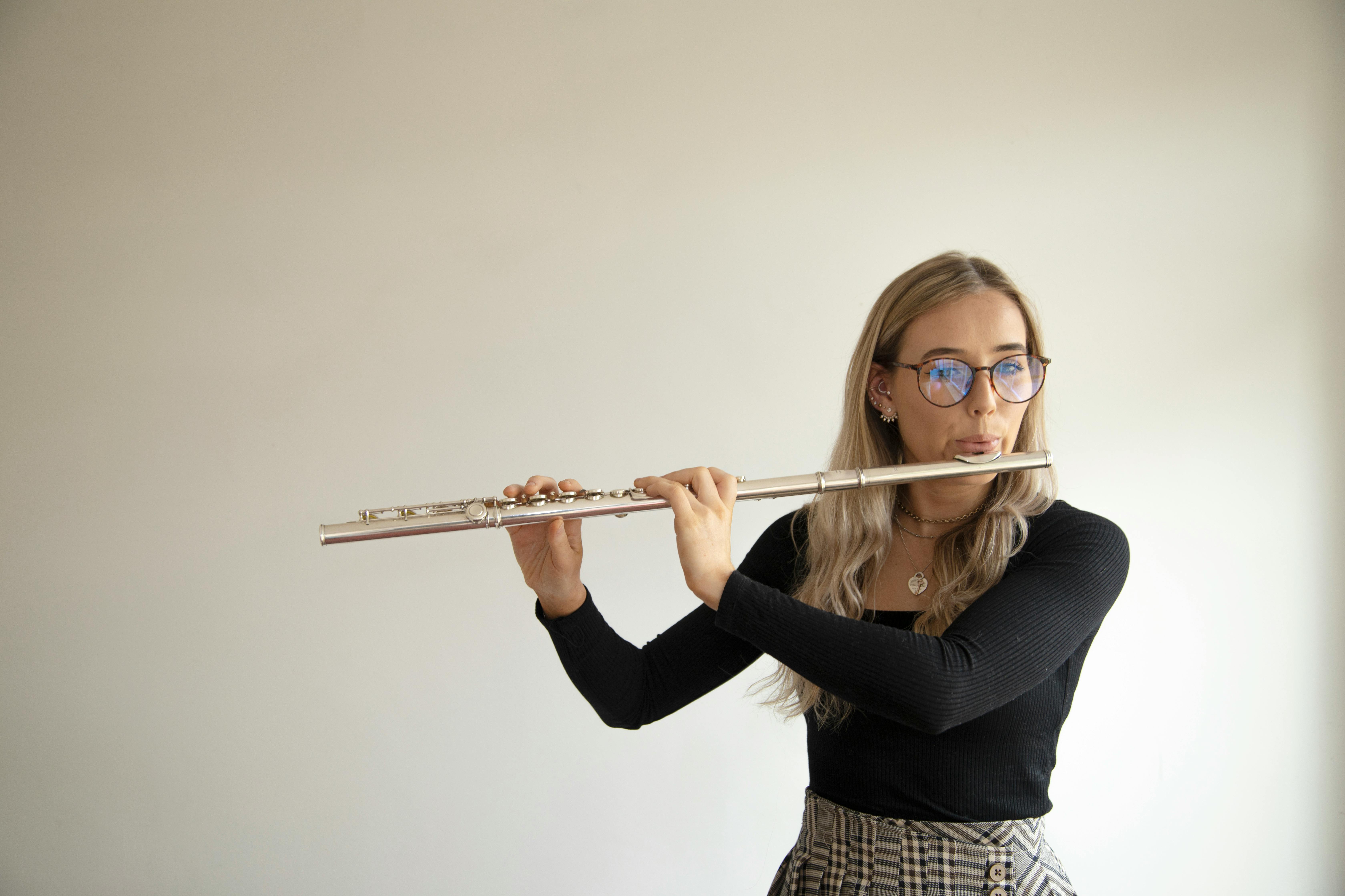 A Flautist Wearing Black Long Sleeves · Free Stock Photo