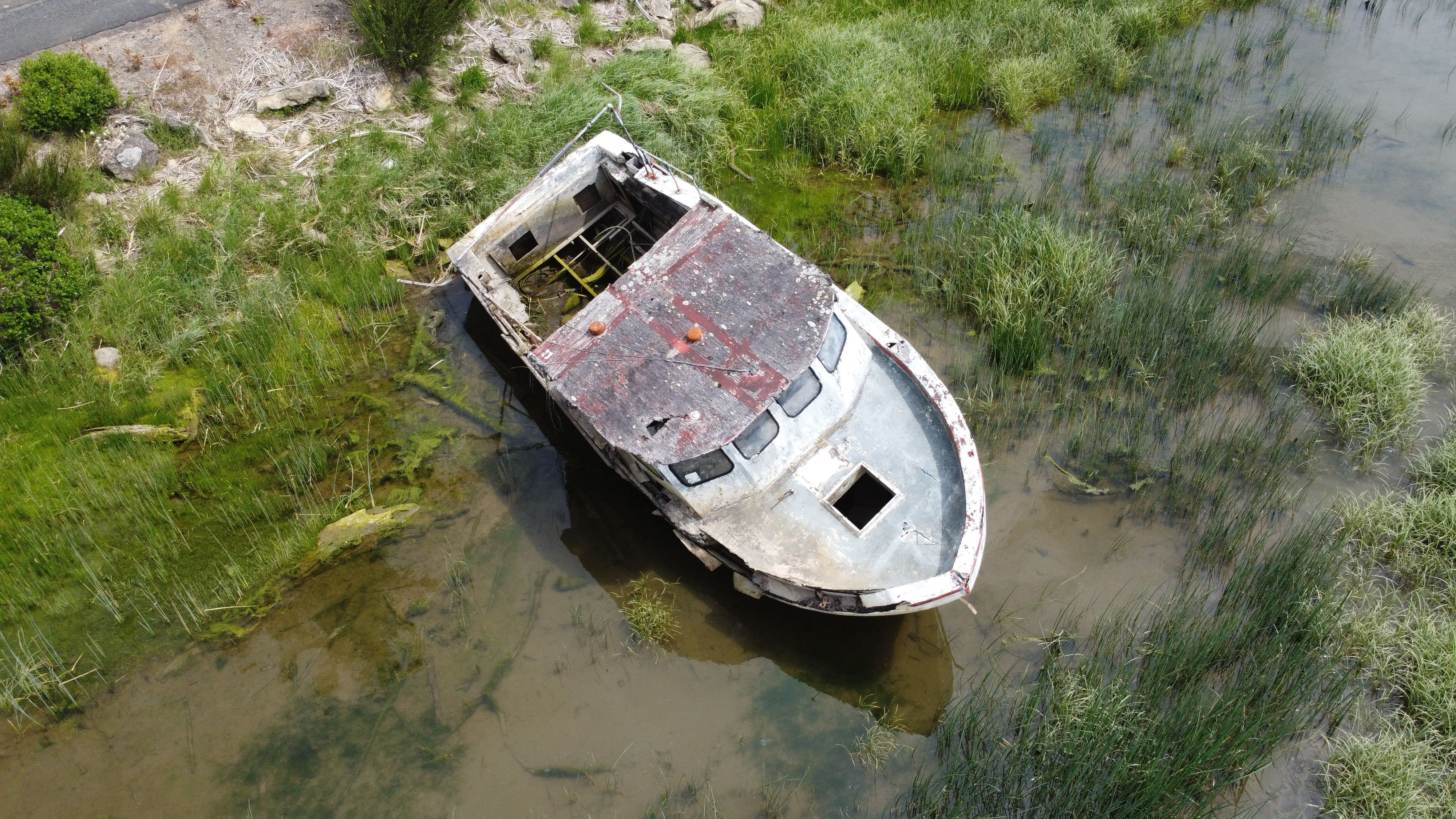 Photo of gray and teal boat on seashore · Free Stock Photo