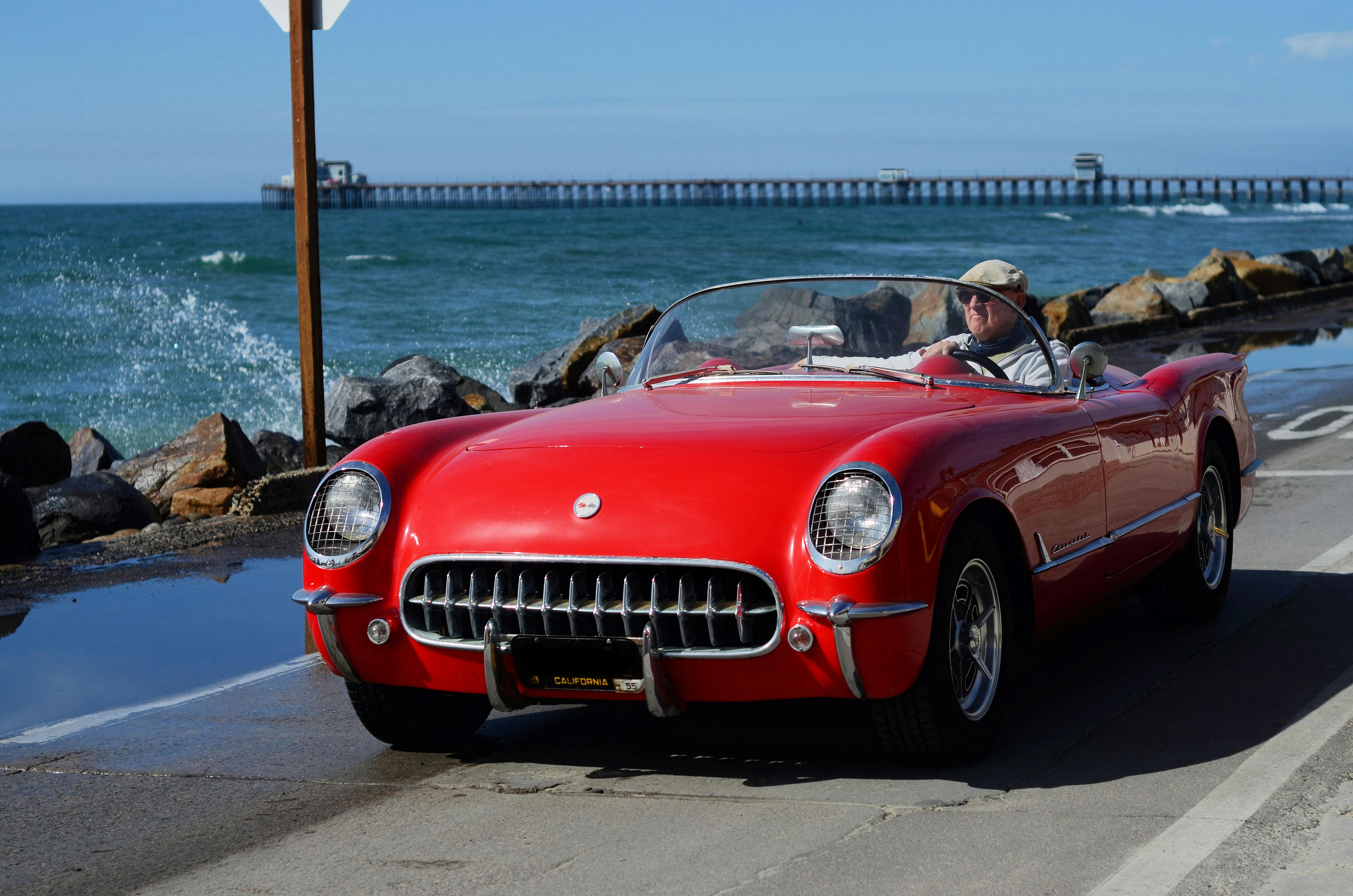 Man Driving a Red Car · Free Stock Photo