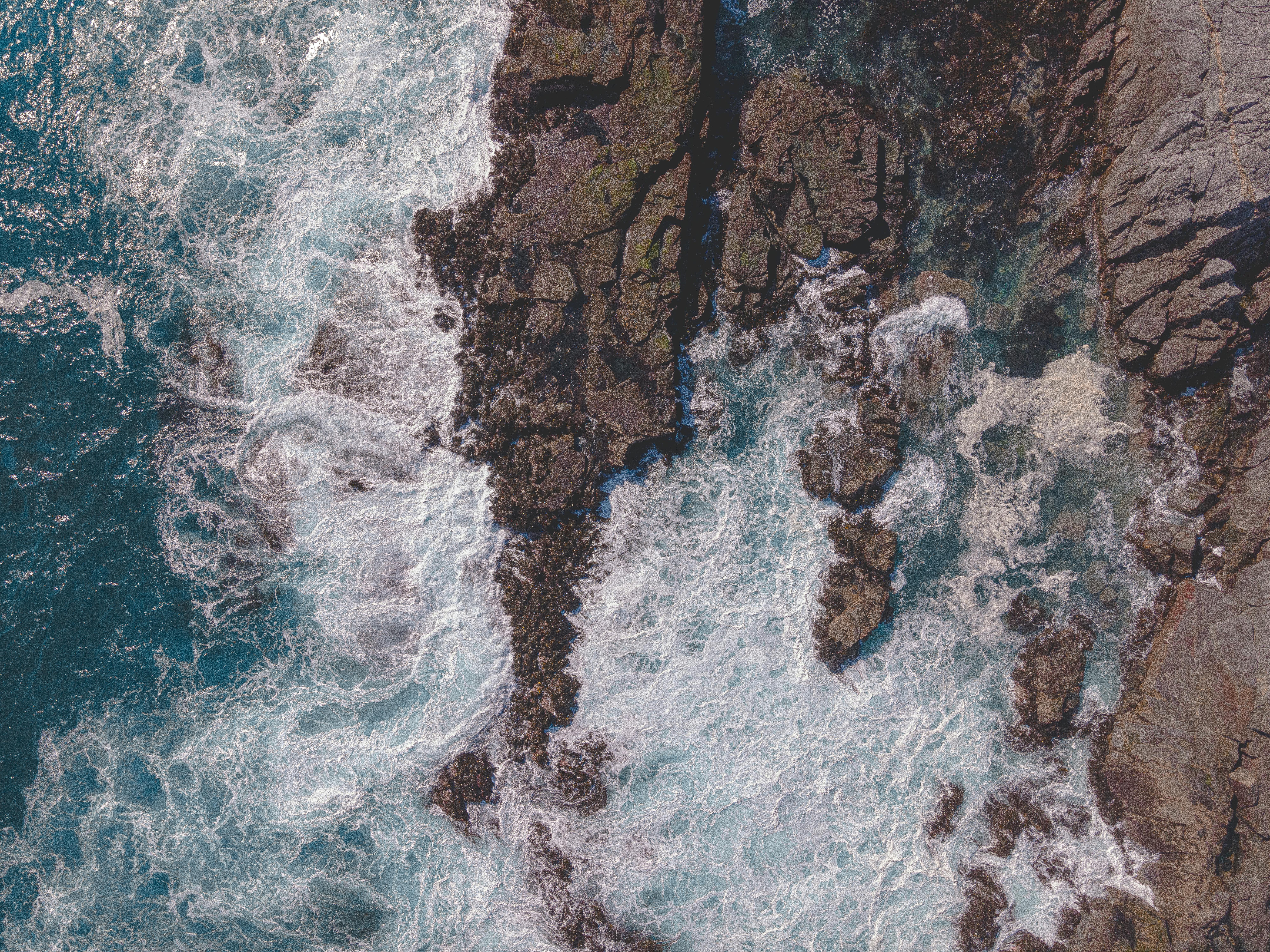 Aerial Shot of Rocks in a Sea · Free Stock Photo