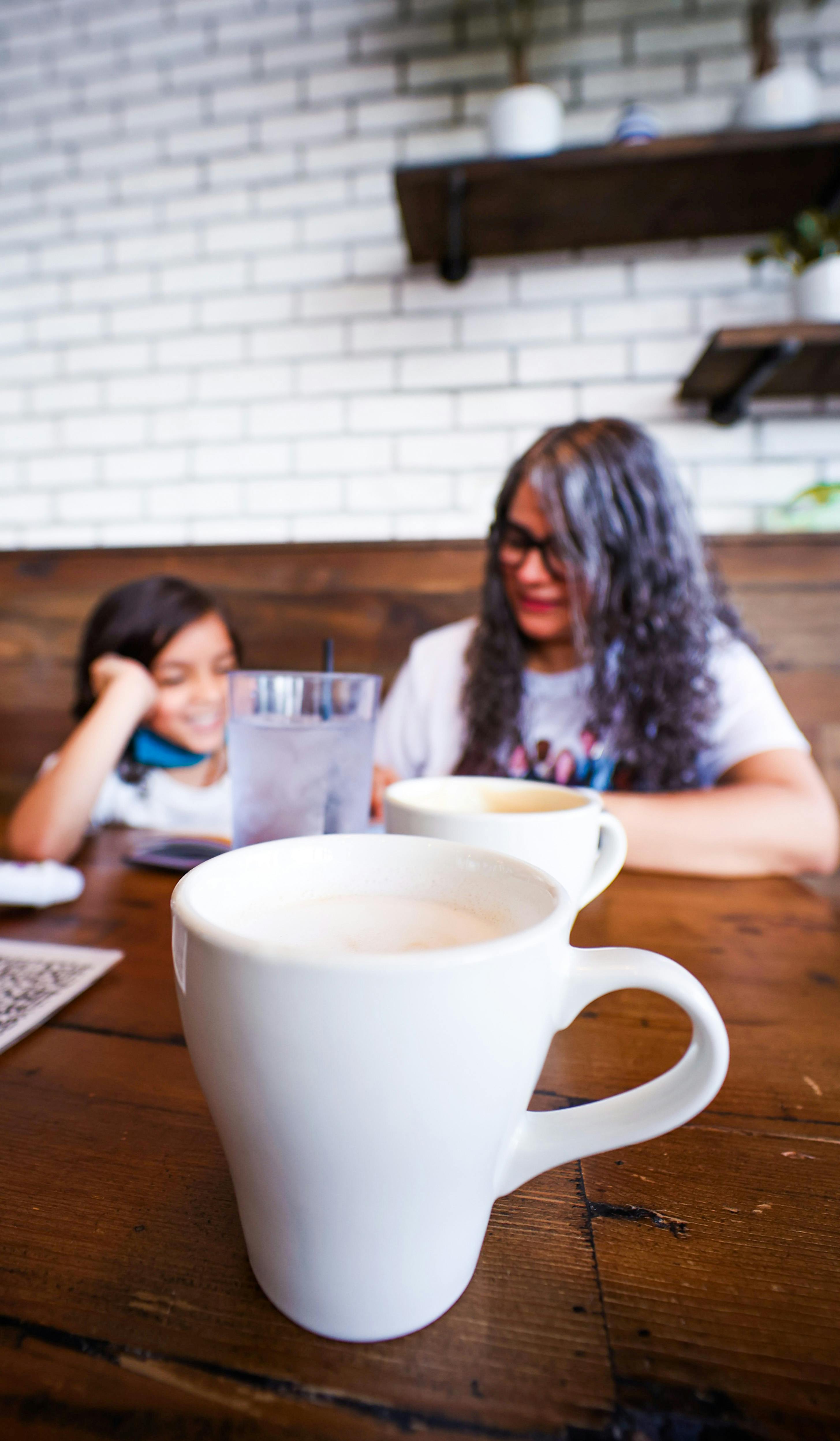 Woman Giving a Boy Drink on White Mug · Free Stock Photo