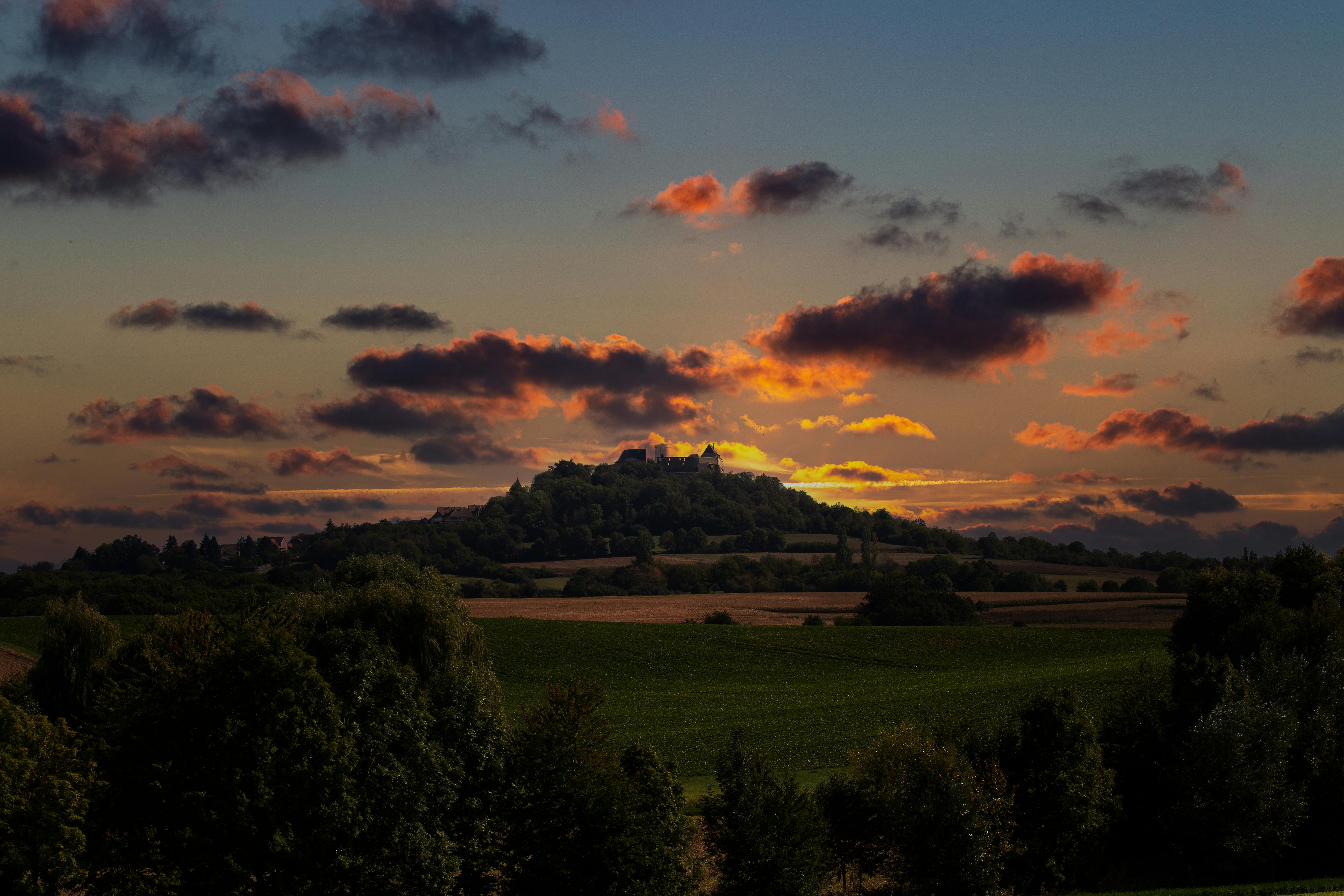 Sun Setting Behind a Hill with a Castle on Top · Free Stock Photo