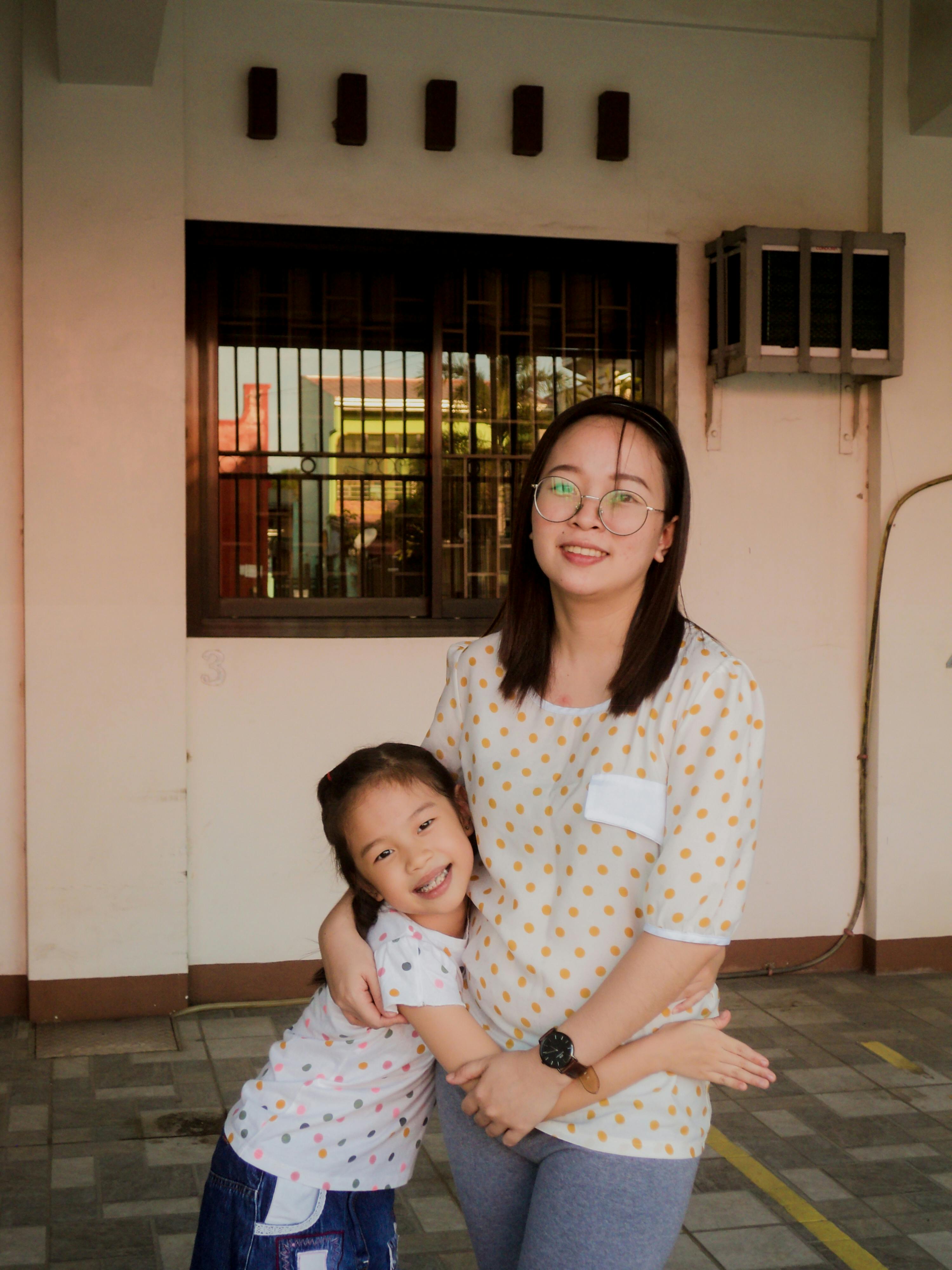 A Woman and a Girl Standing Near Directional Signage · Free Stock Photo