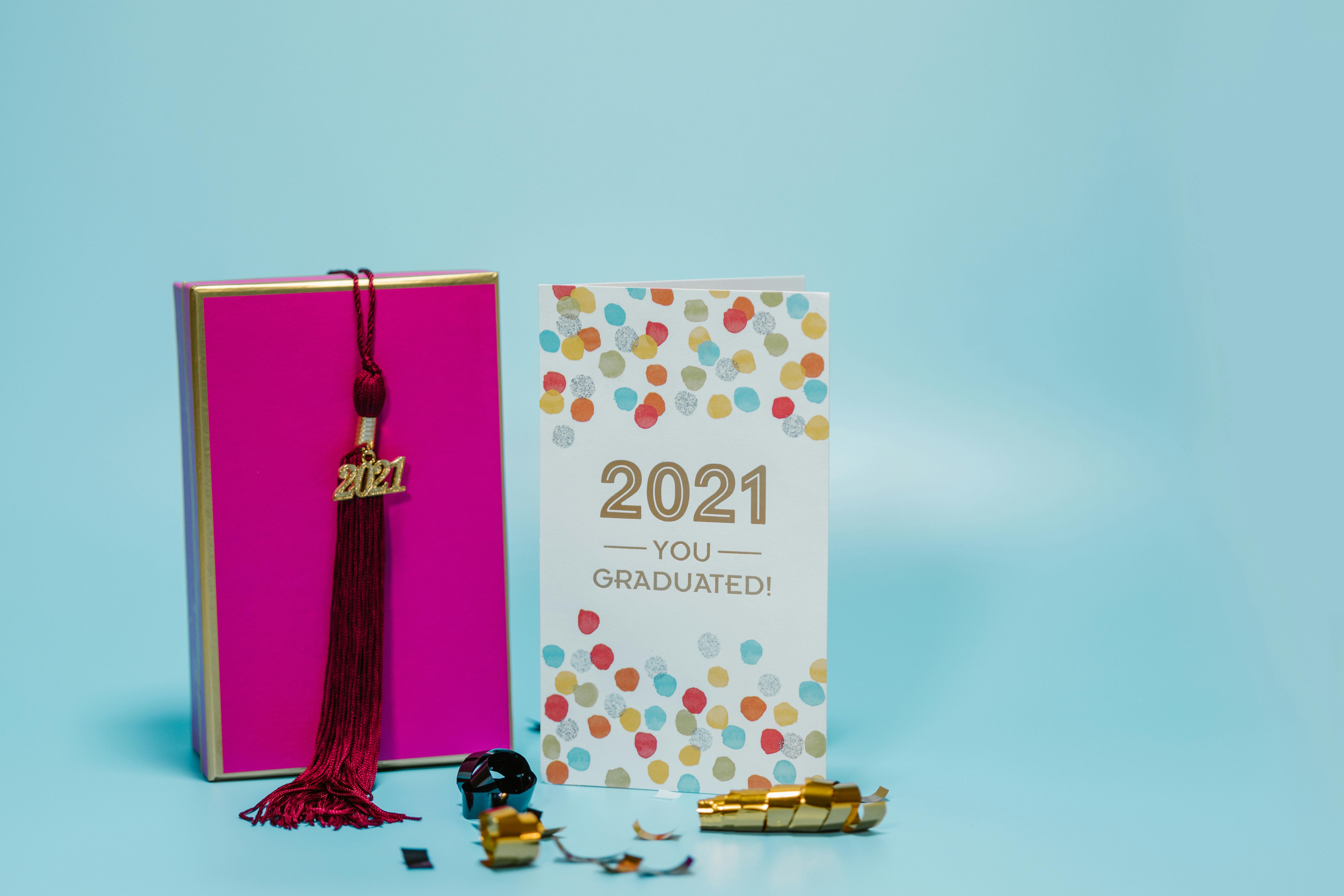 Photo of a Graduation Card and Red Tassel · Free Stock Photo