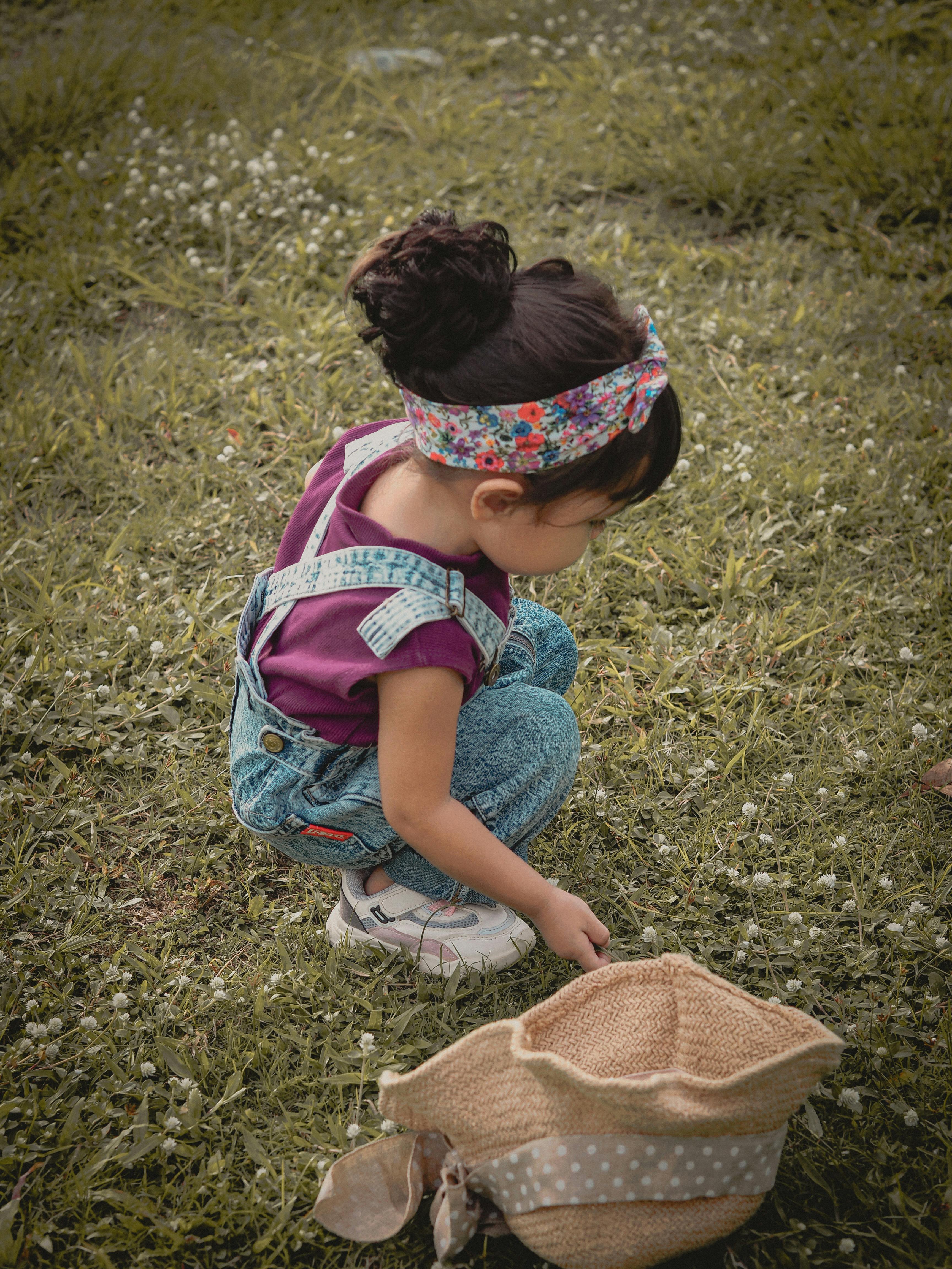 Photo of an Upset Kid Crouching · Free Stock Photo