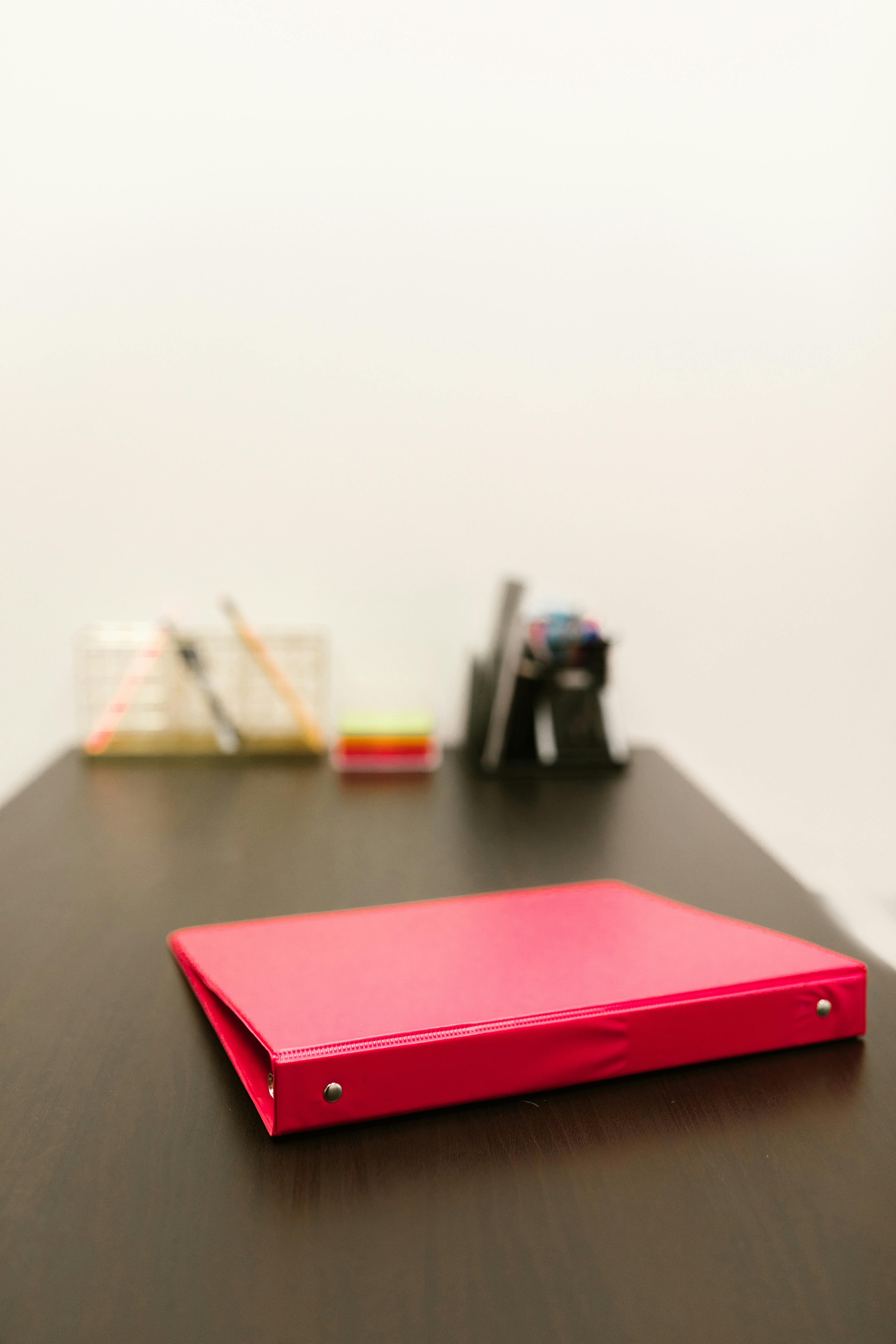 Close-Up Shot of a Red Organizer on the Table · Free Stock Photo