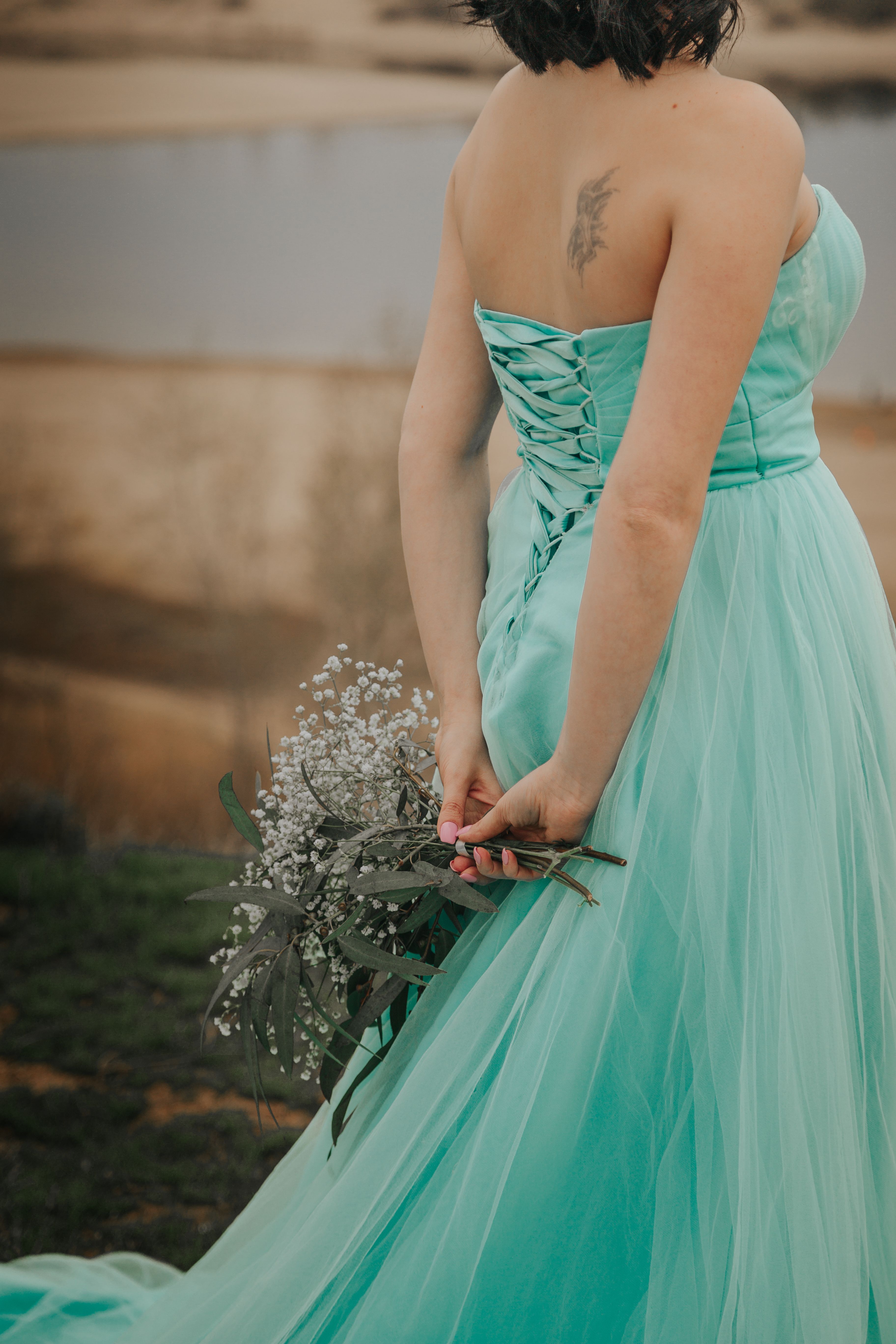 Crop bride with flowers and tattoo in evening countryside · Free Stock ...