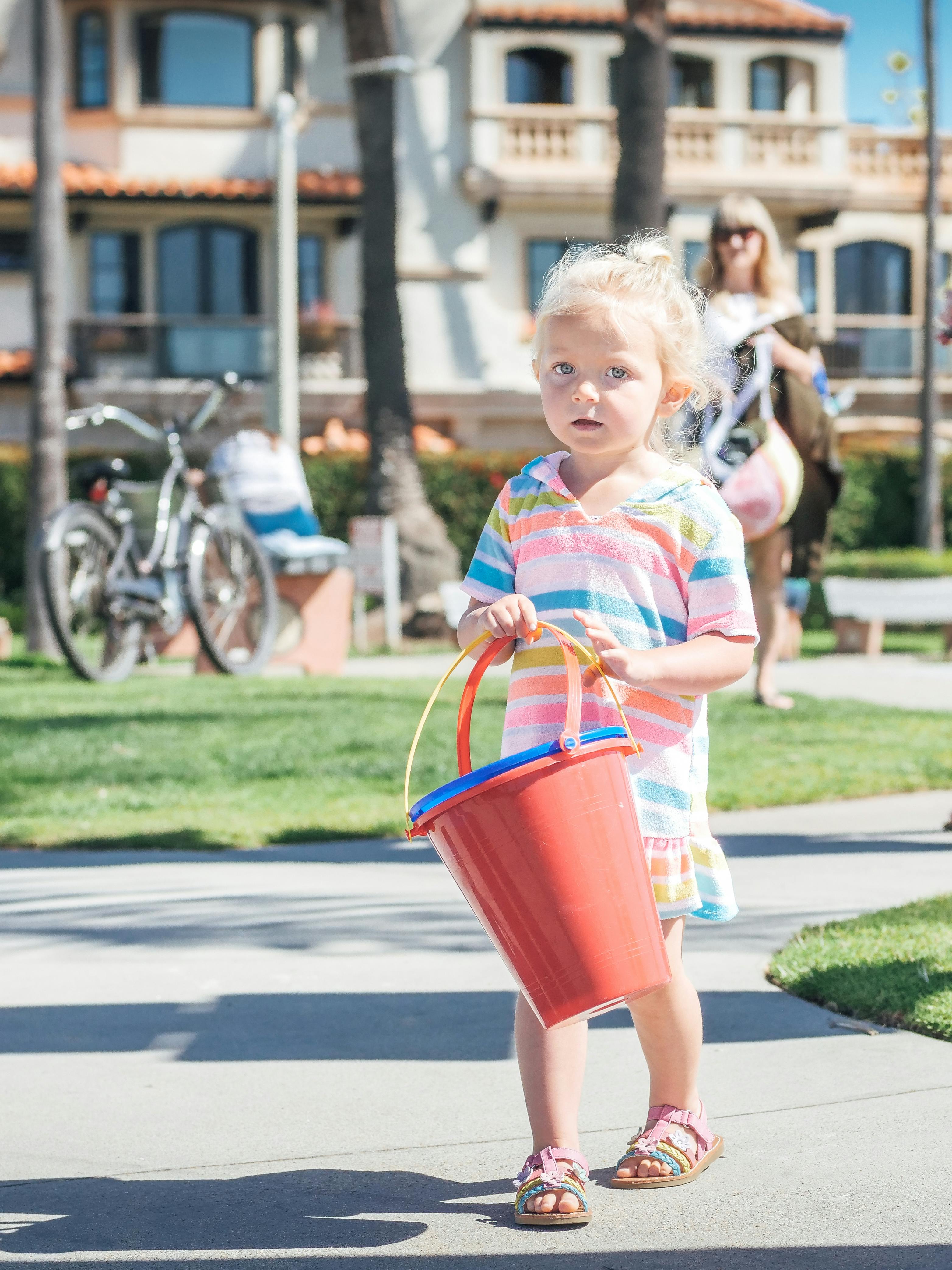 Girl Carrying a Plastic Bucket · Free Stock Photo