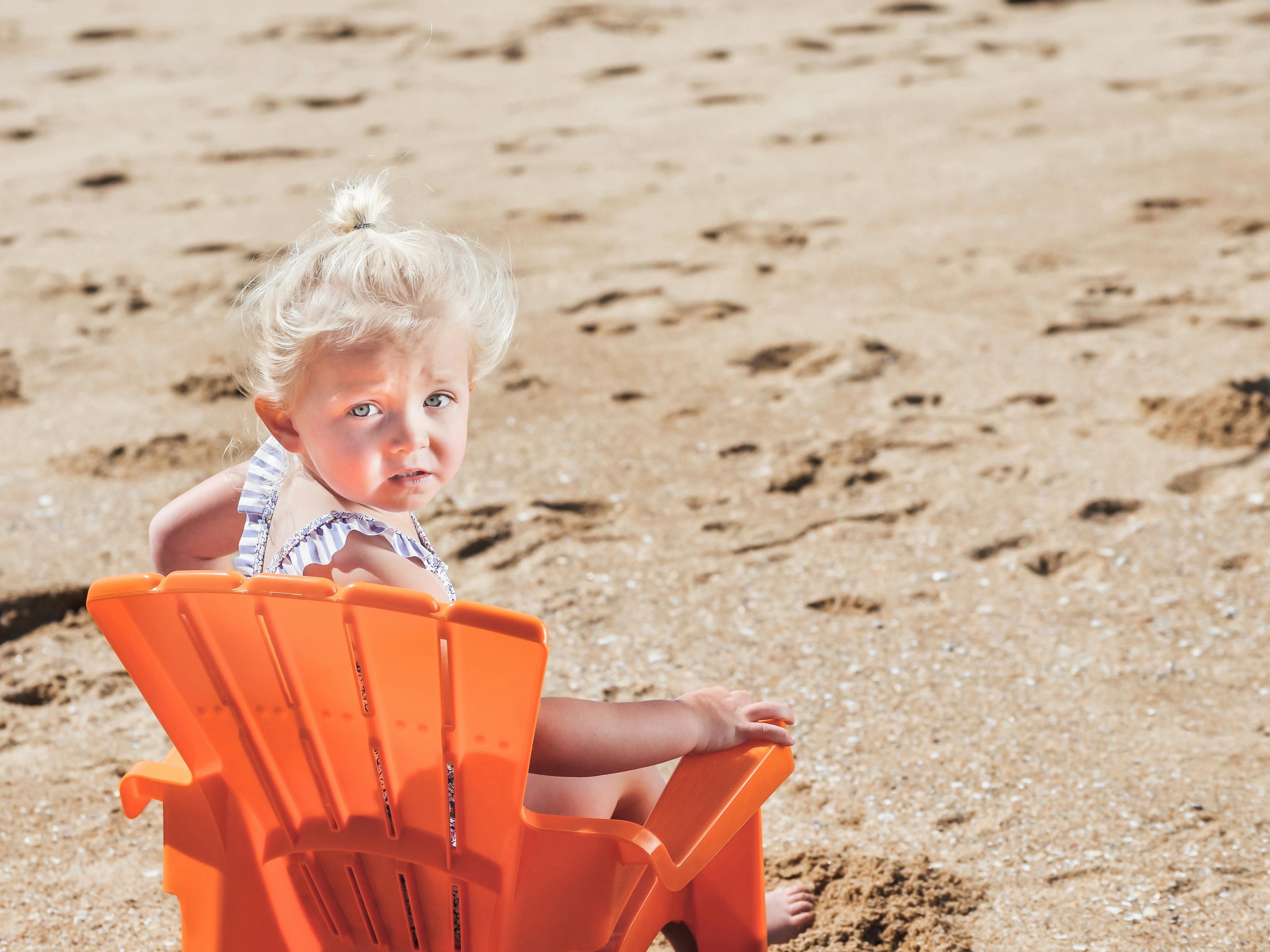 Girl in Blue Shirt Touching Sand · Free Stock Photo
