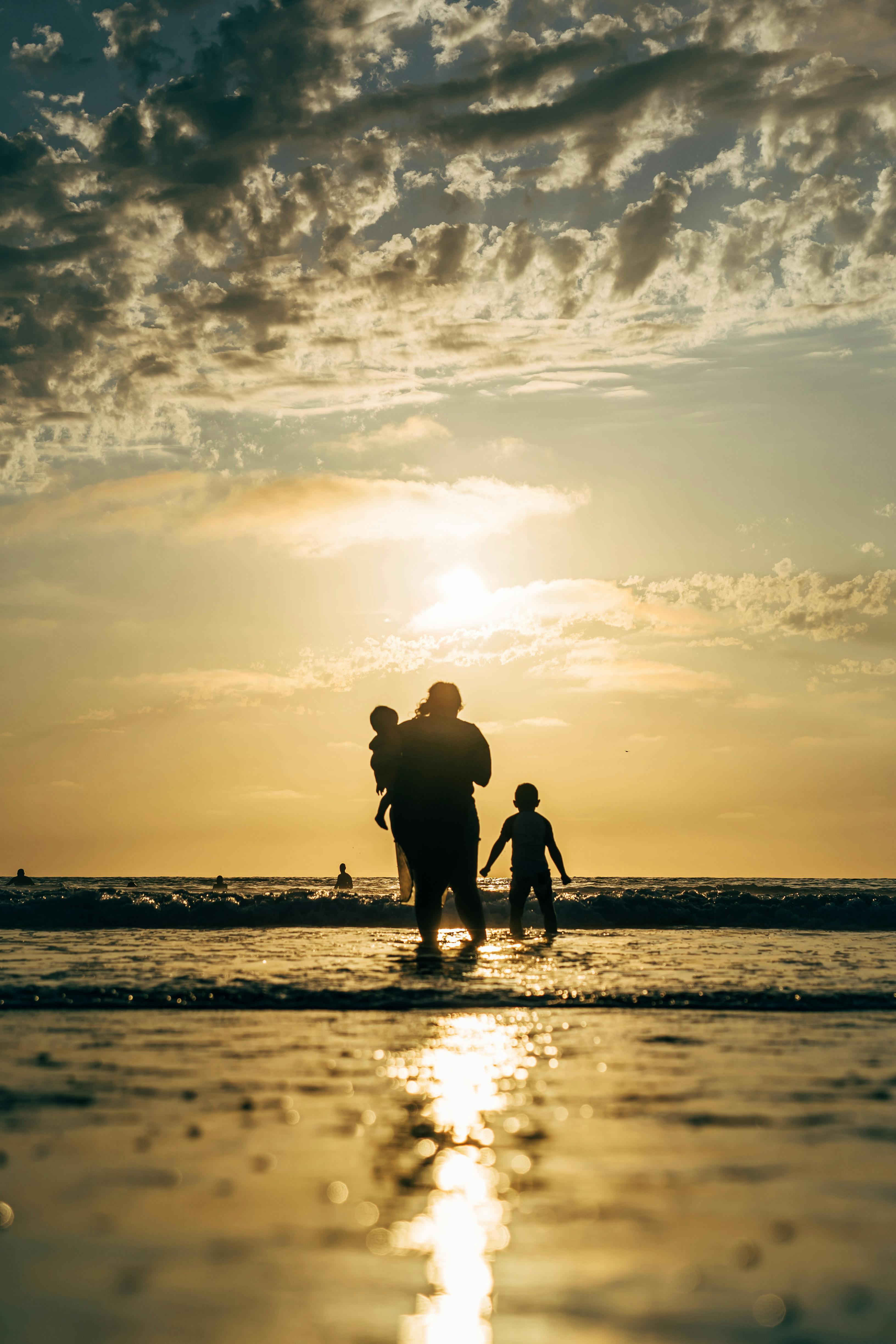 Silhouette of a Family at the Beach · Free Stock Photo