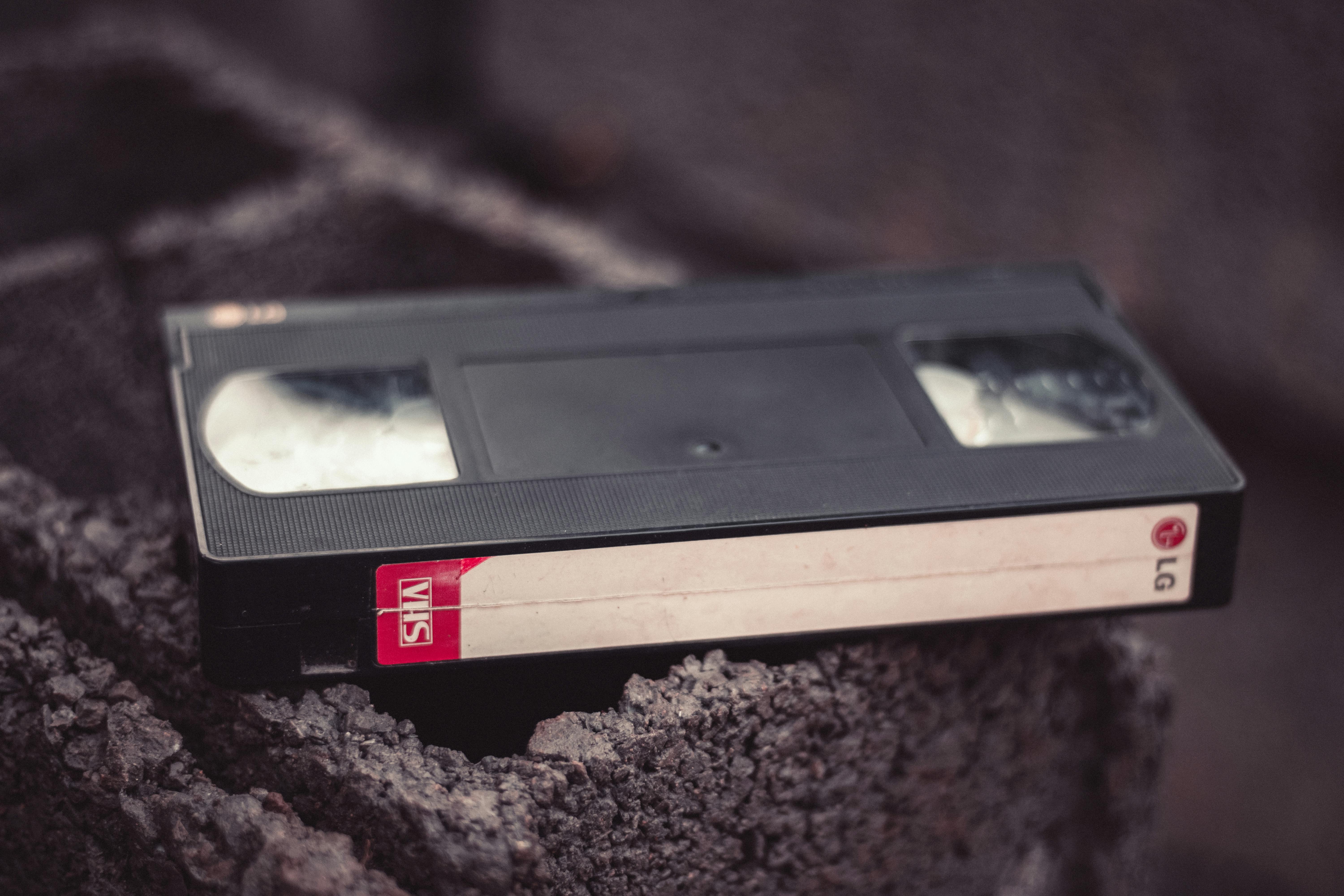 Person Holding a VHS Videotape · Free Stock Photo