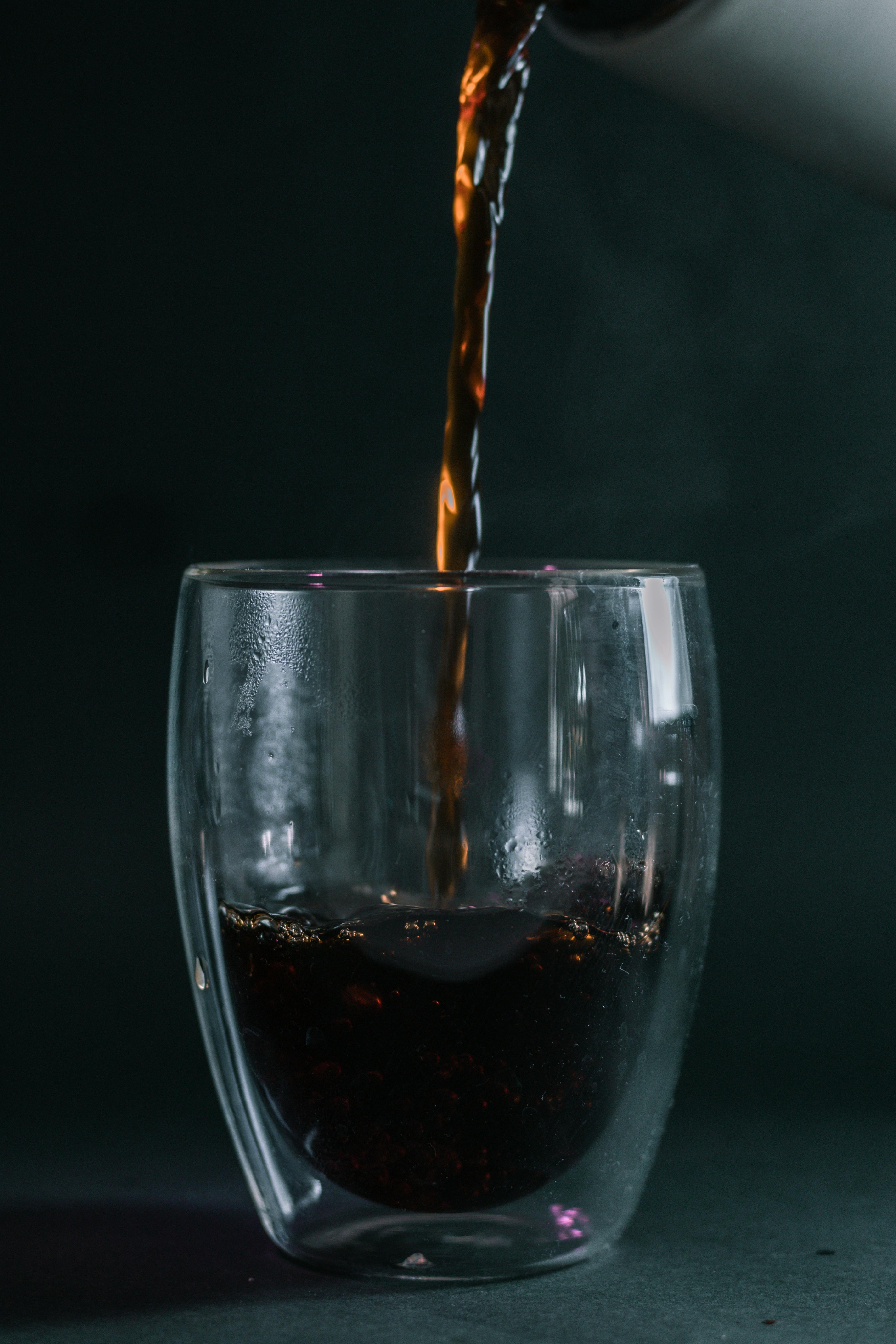 Hot coffee pouring into glass cup · Free Stock Photo