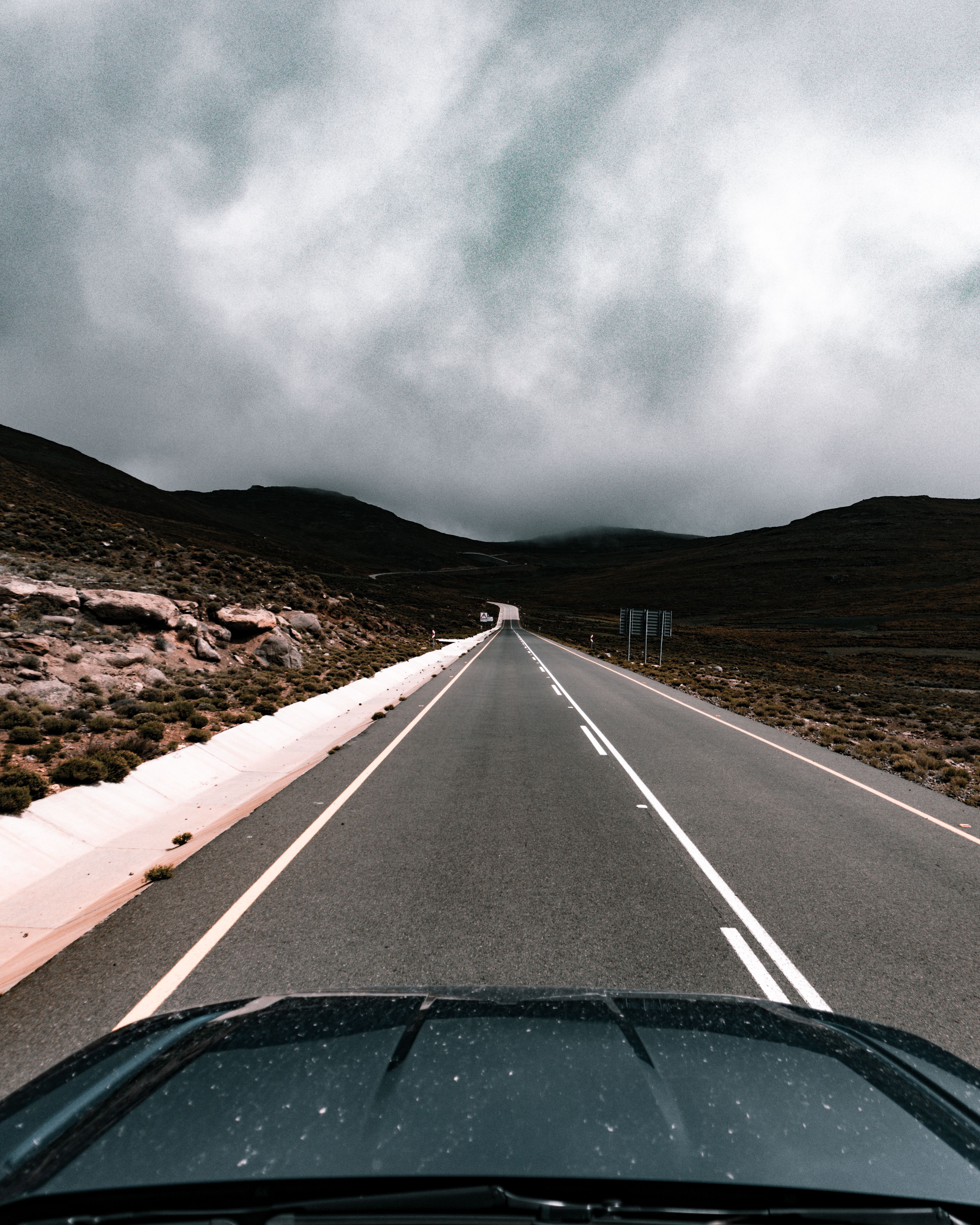 Cirrus Clouds over Empty Black Road · Free Stock Photo