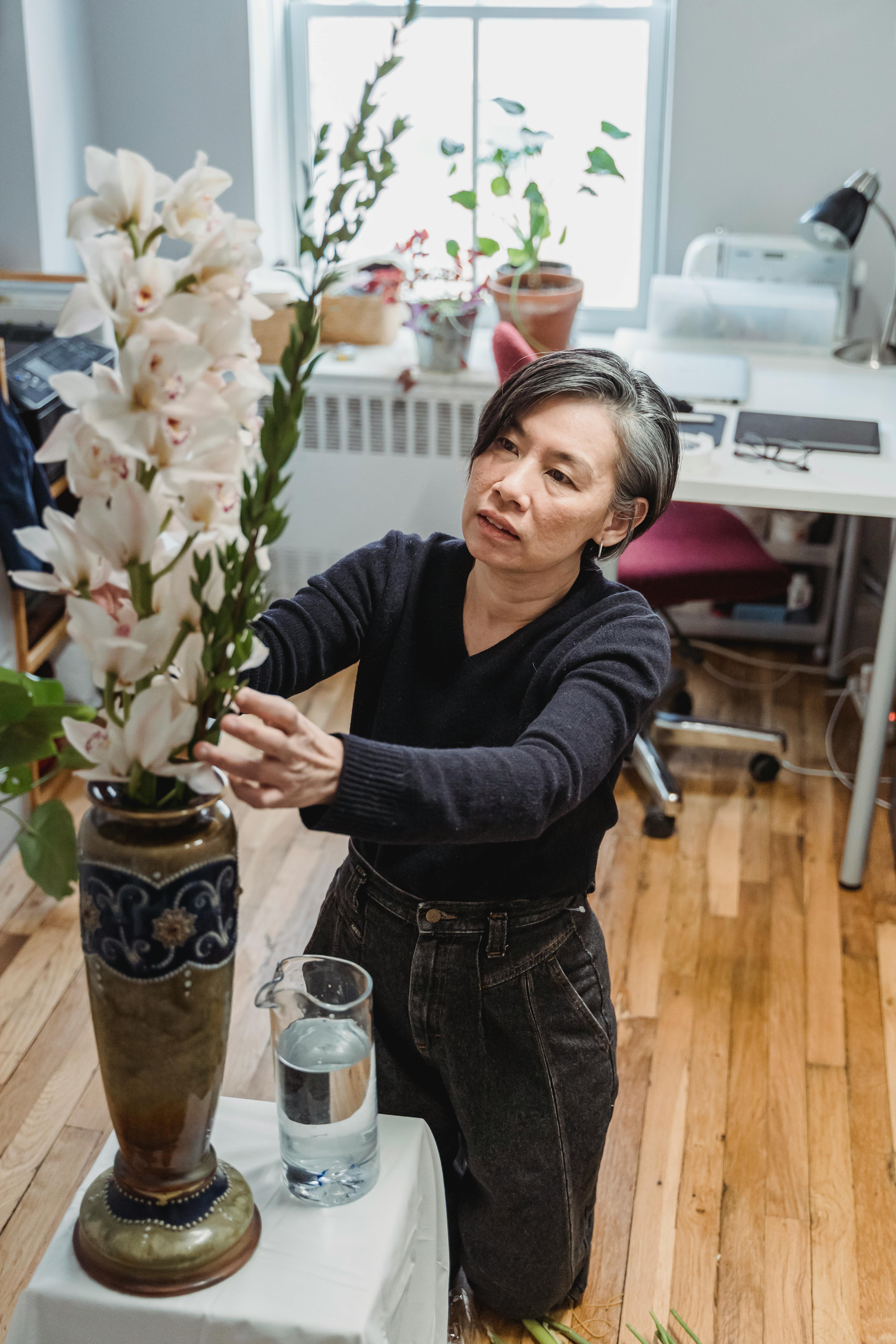 A Woman Arranging Flowers · Free Stock Photo