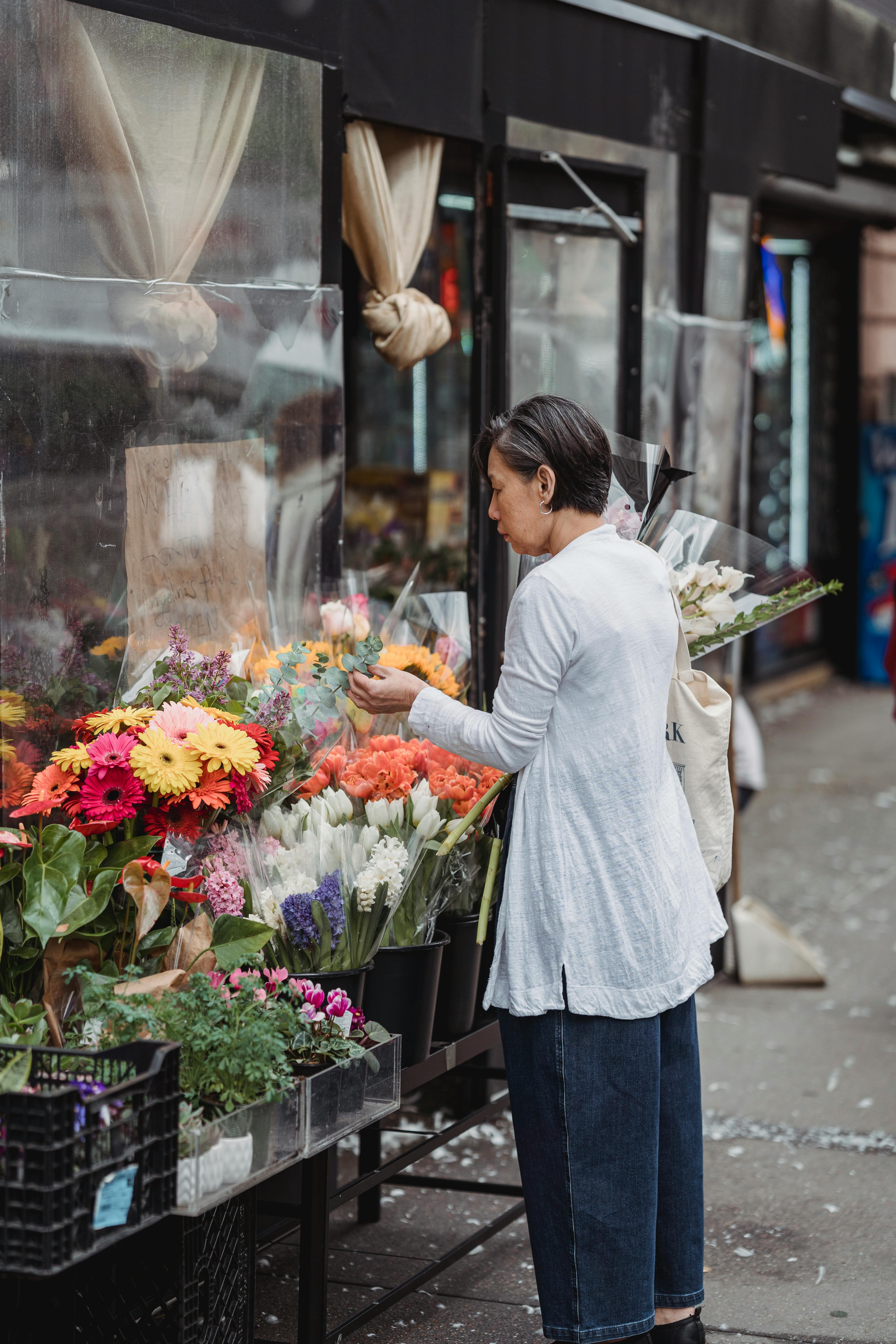 Woman Looking at Flowers · Free Stock Photo