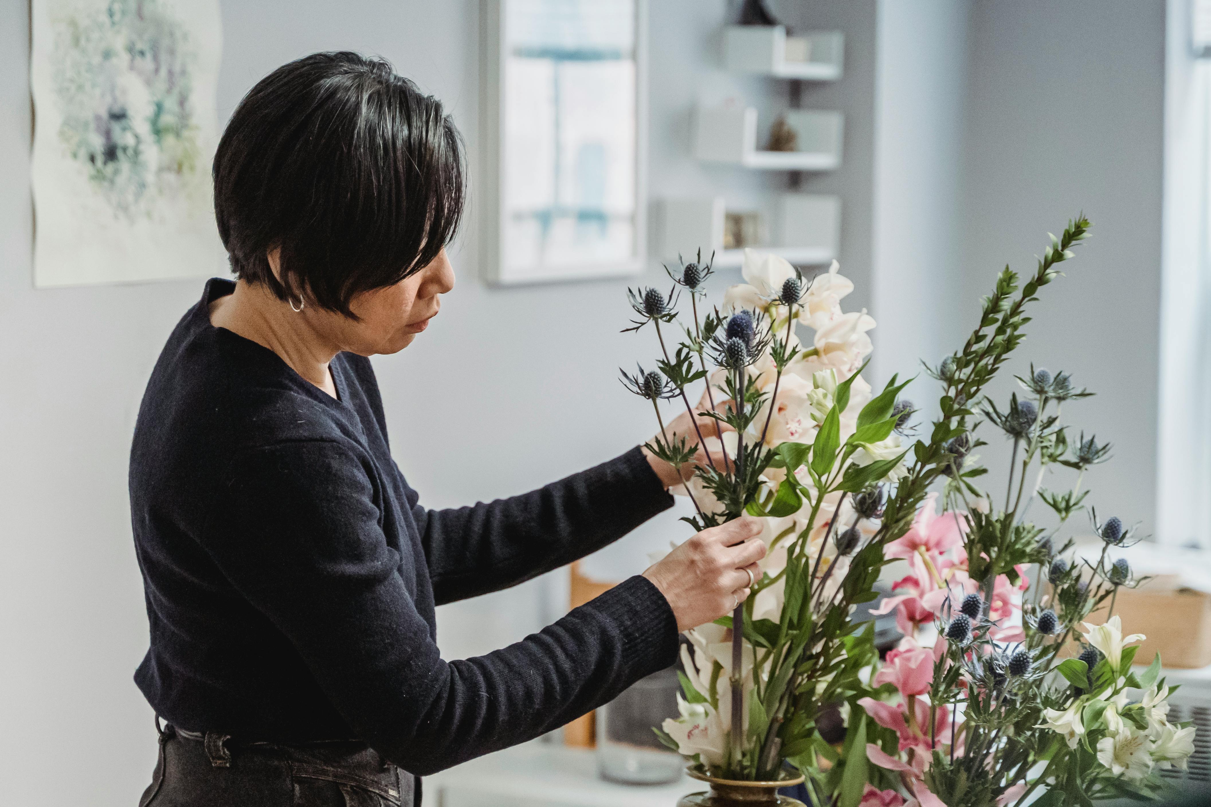 A Woman Arranging Flowers · Free Stock Photo