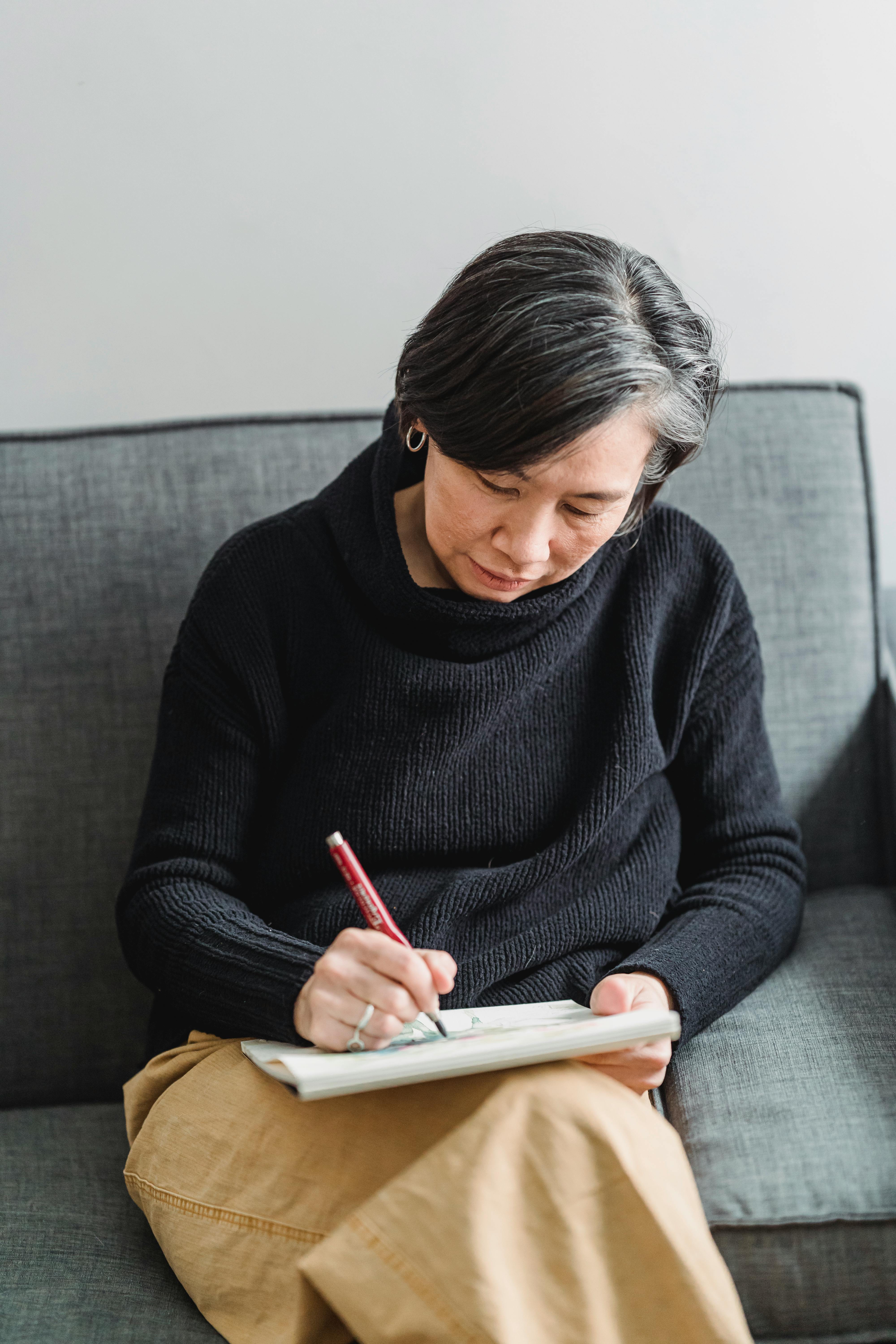 Woman Drawing an Artwork in a Sketchpad · Free Stock Photo