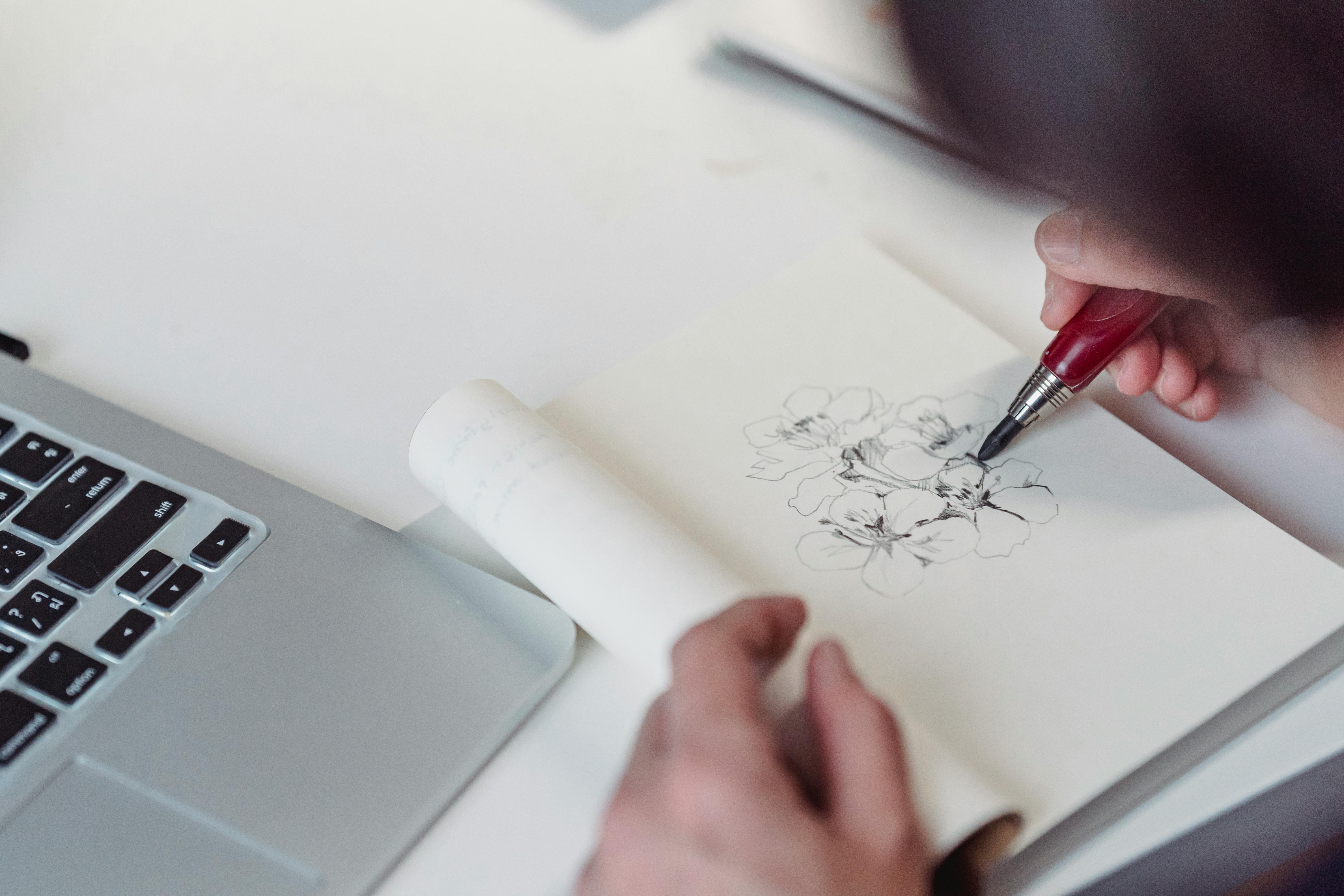 Close-Up Shot of a Person Drawing an Artwork · Free Stock Photo