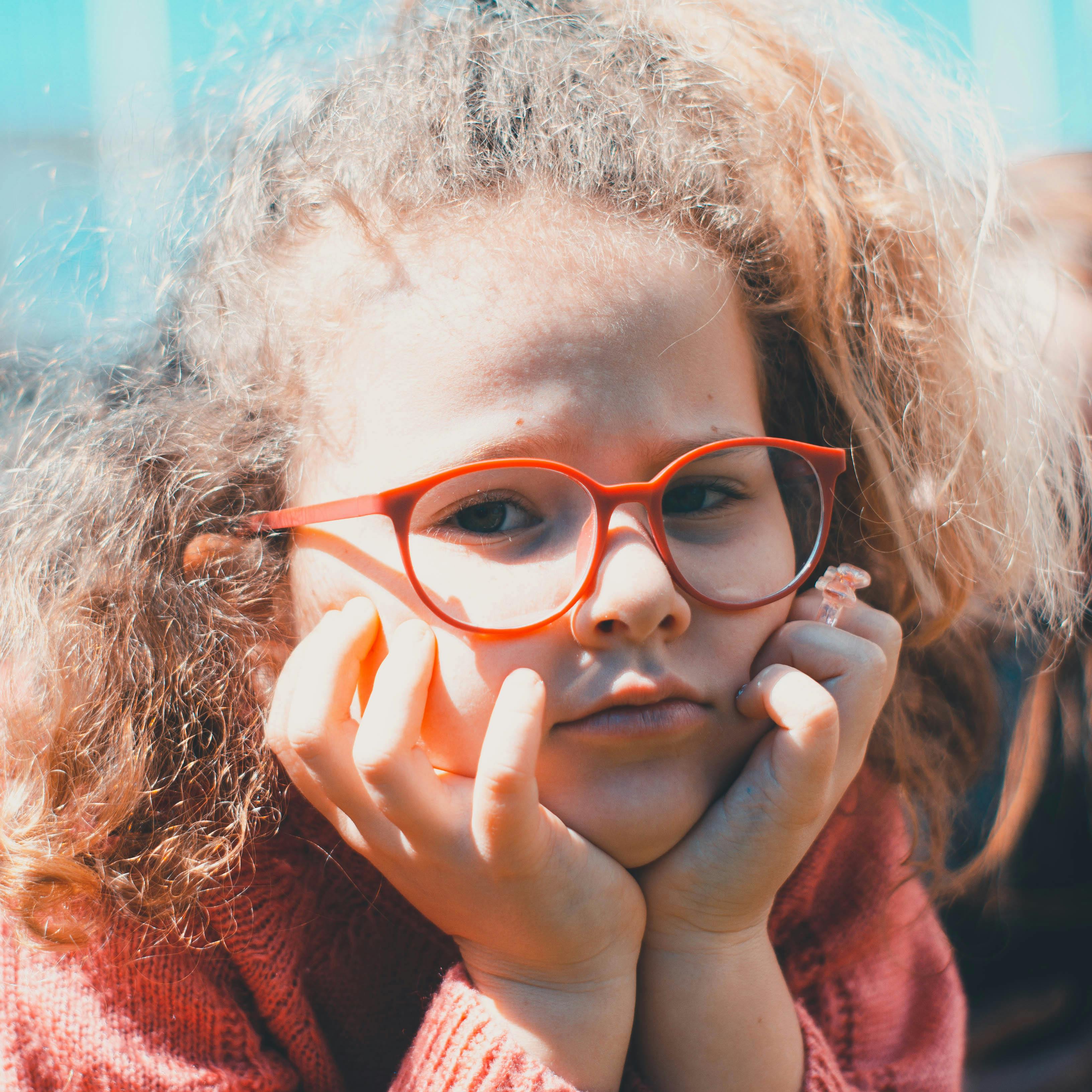 Photo of an Upset Kid Crouching · Free Stock Photo
