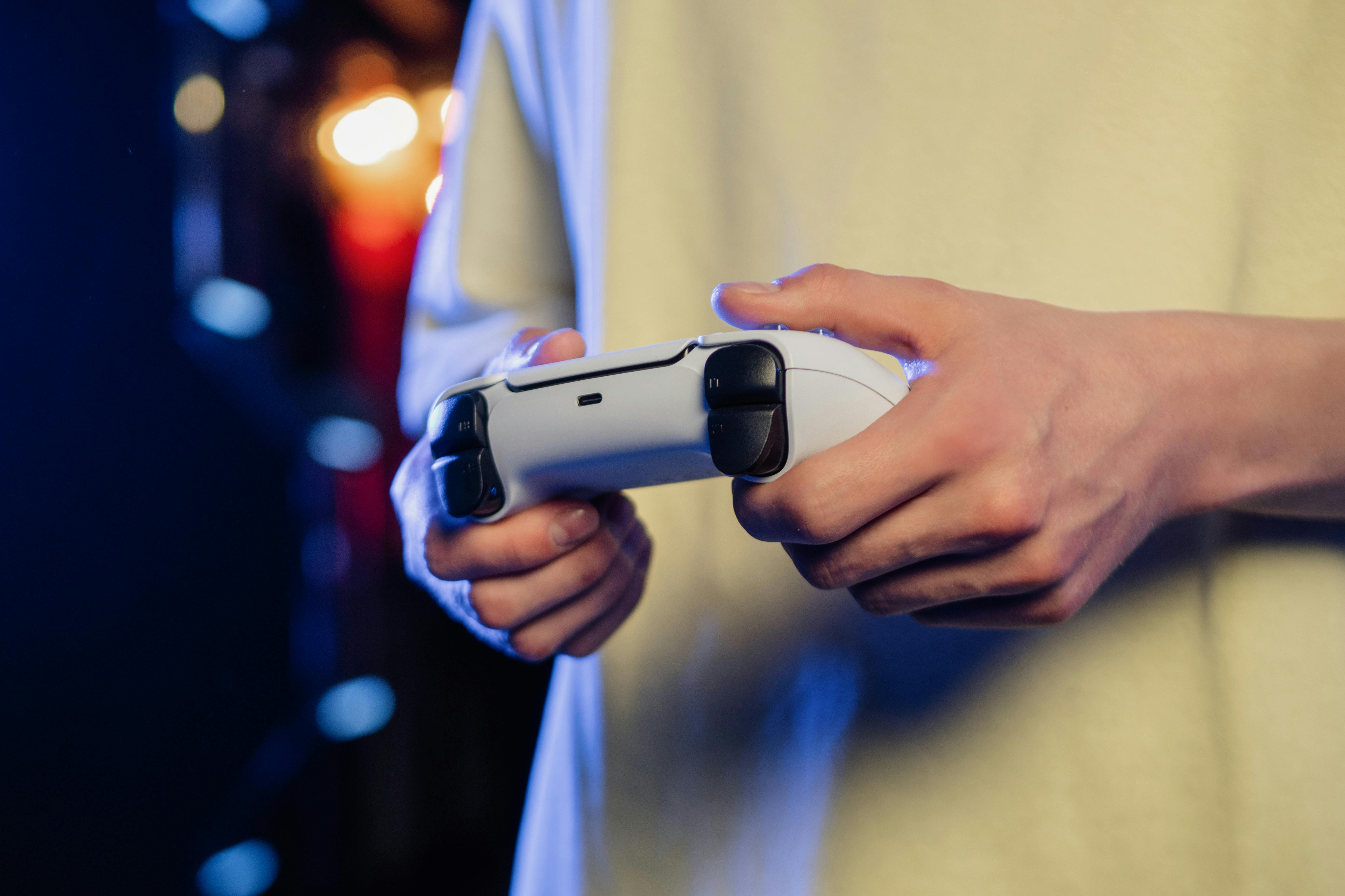 A Person Holding a Game Controller · Free Stock Photo