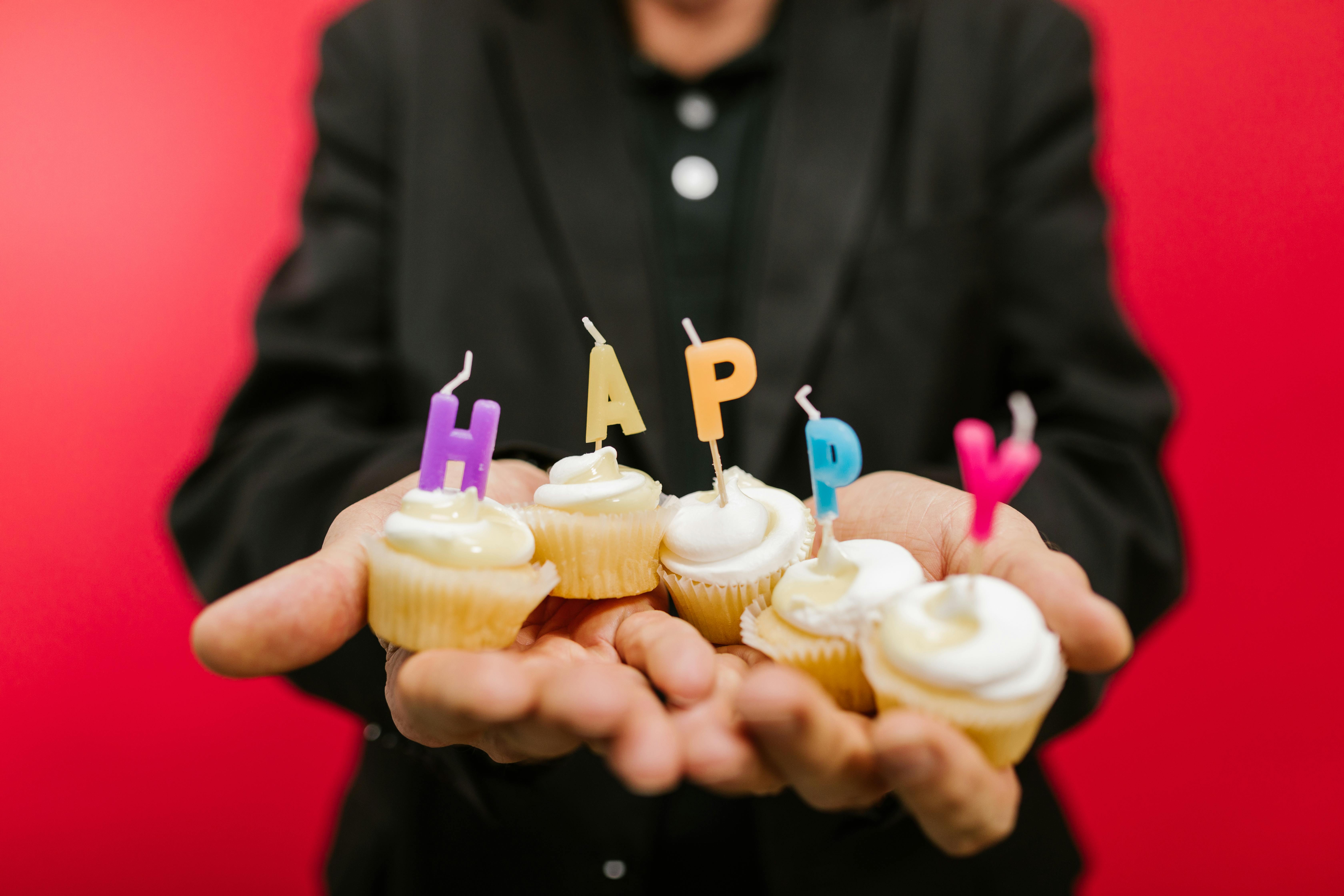 Person Holding White and Brown Cake With Pink Icing · Free Stock Photo