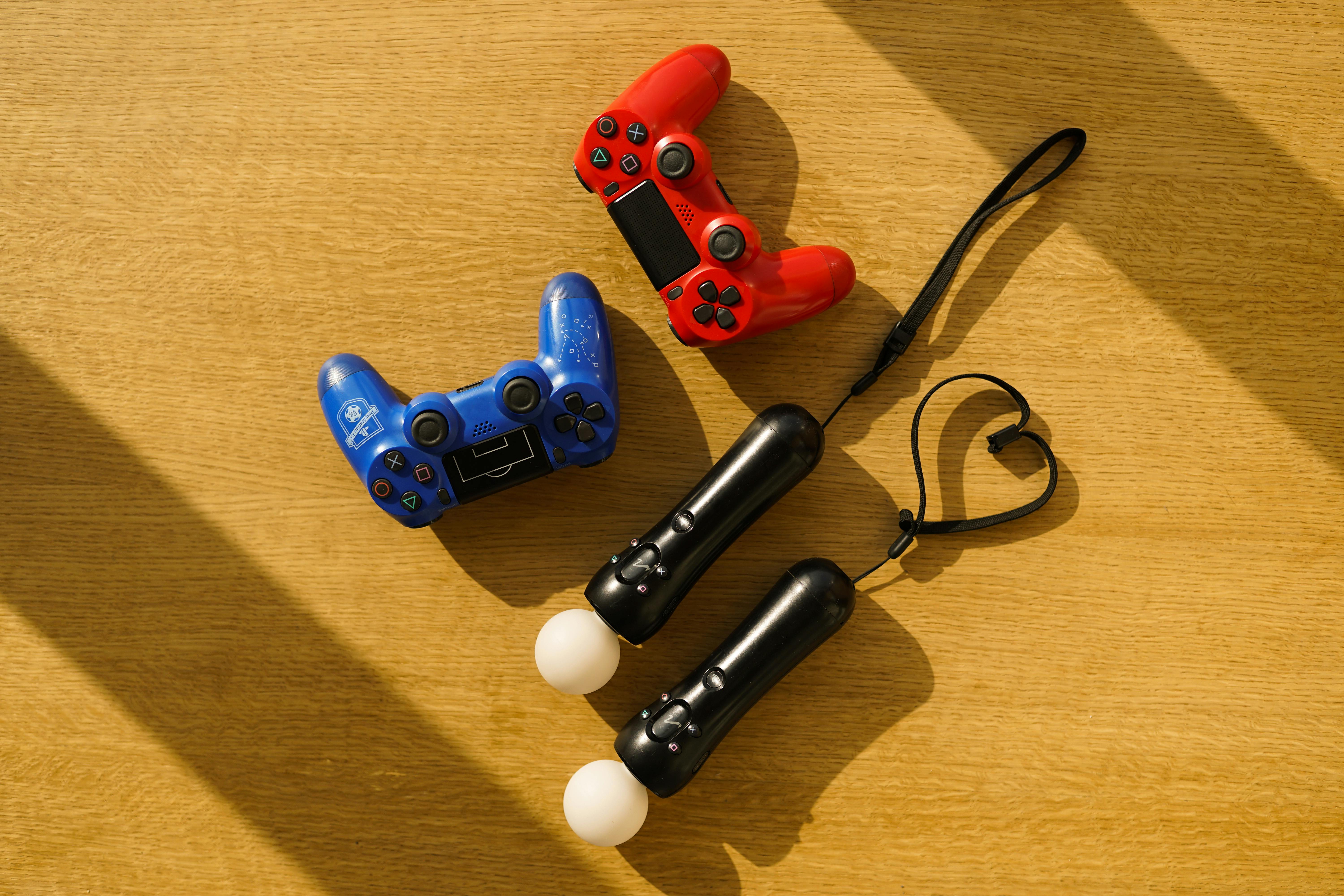 Game Controllers on a Wooden Surface · Free Stock Photo