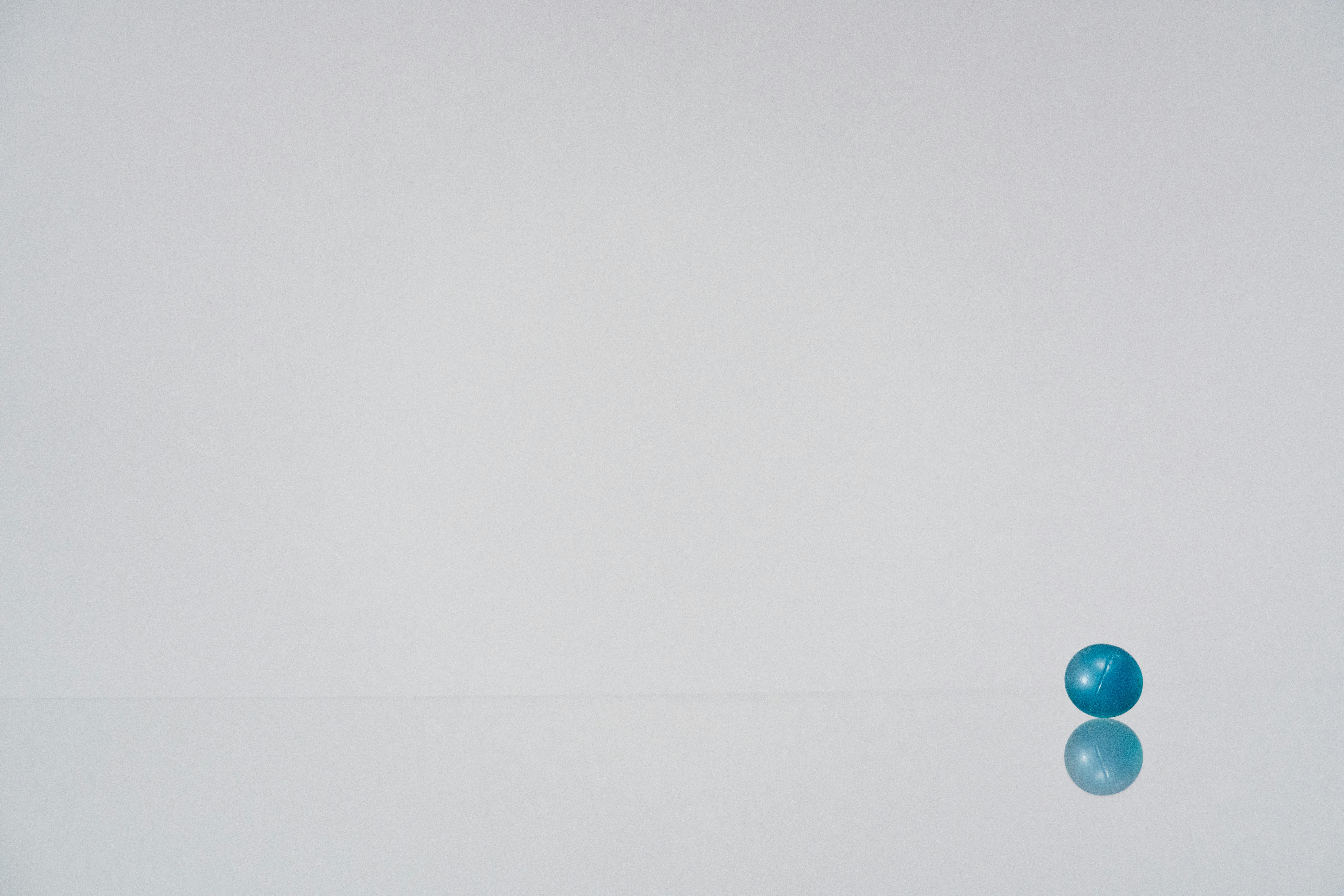 A Blue Round Object on a White Surface · Free Stock Photo