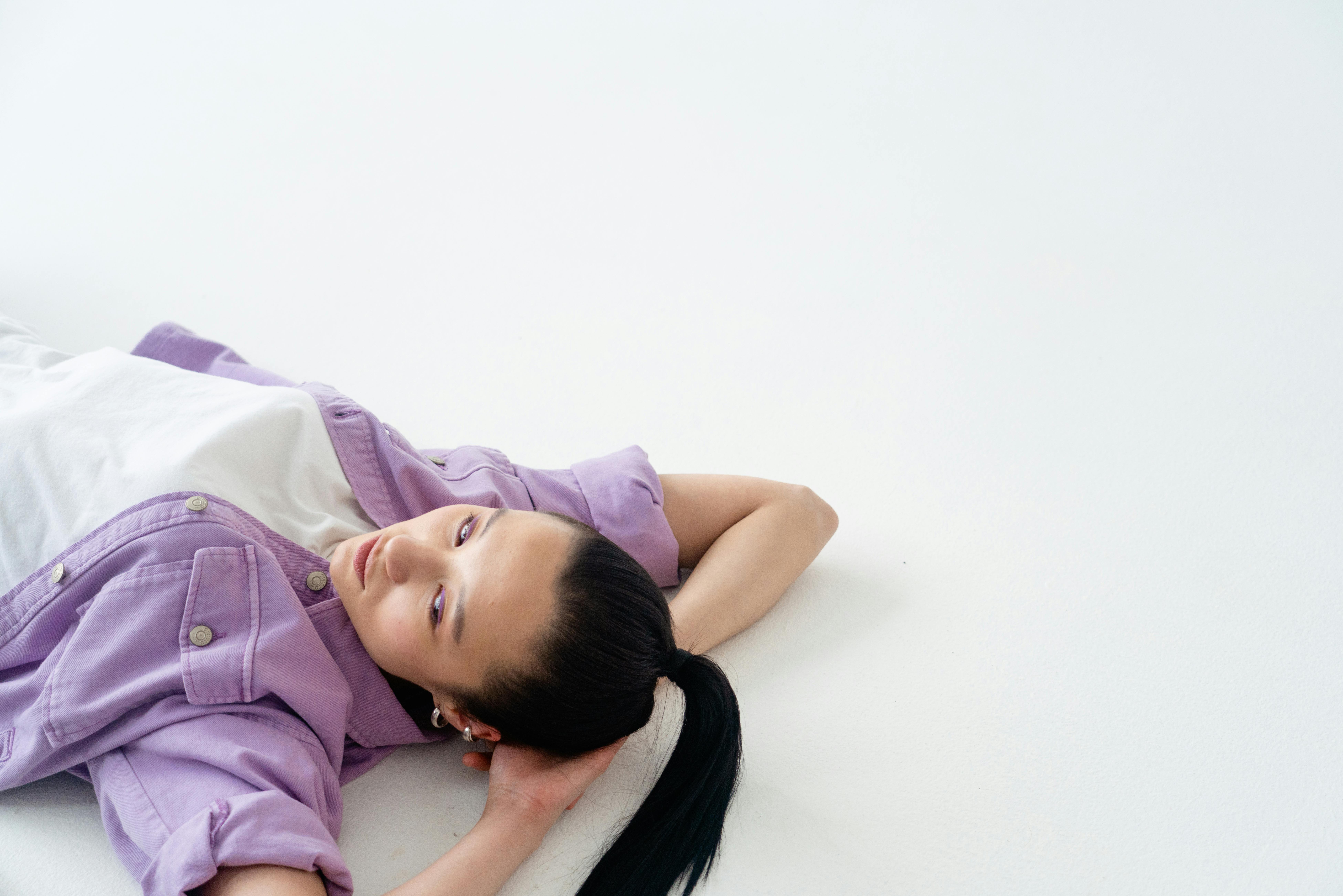 A Woman in Purple Jacket Lying on the Floor · Free Stock Photo