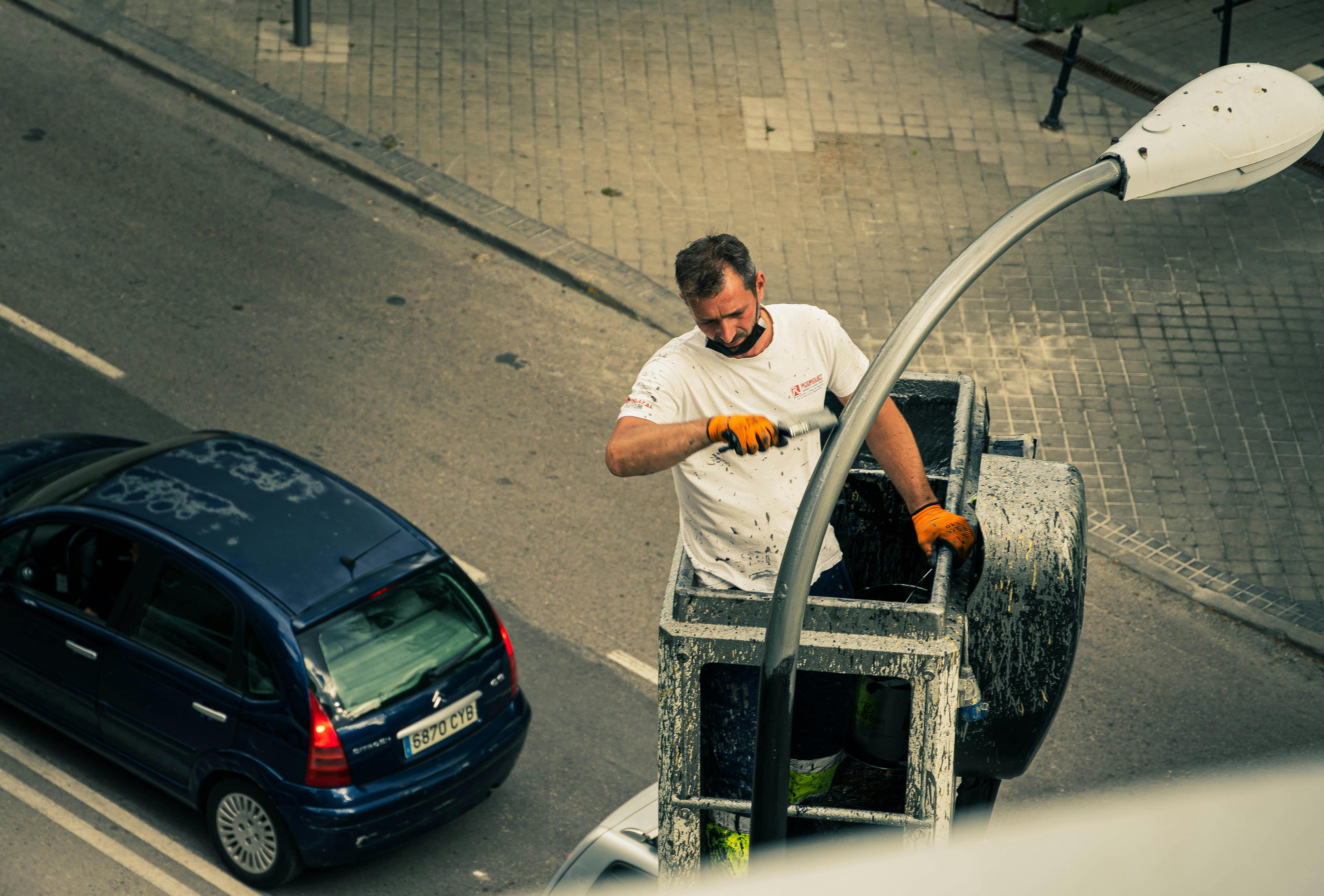 A Man Repairing a Streetlight · Free Stock Photo
